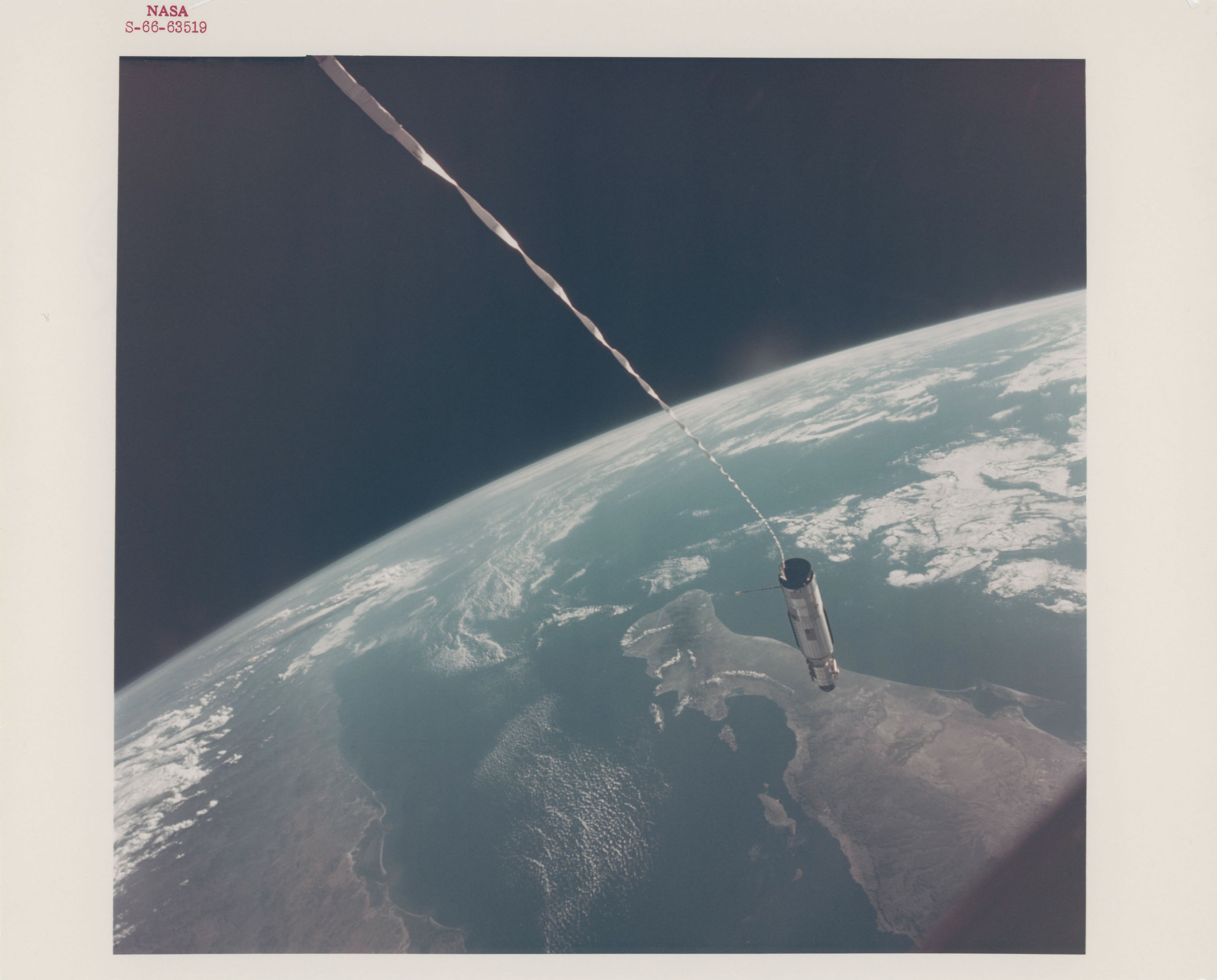 Views of Agena tethered to Gemini XII over the Earth horizon; over Houston and the Texas Gulf ...