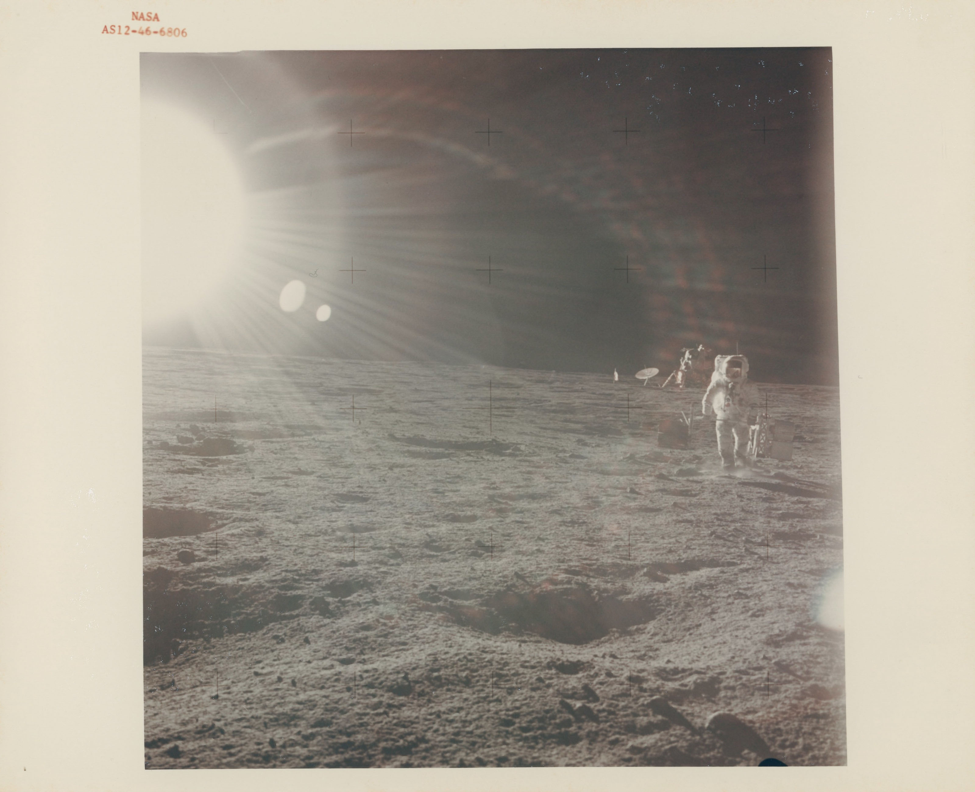 Alan Bean transporting scientific equipment; astronaut’s shadow; the ...