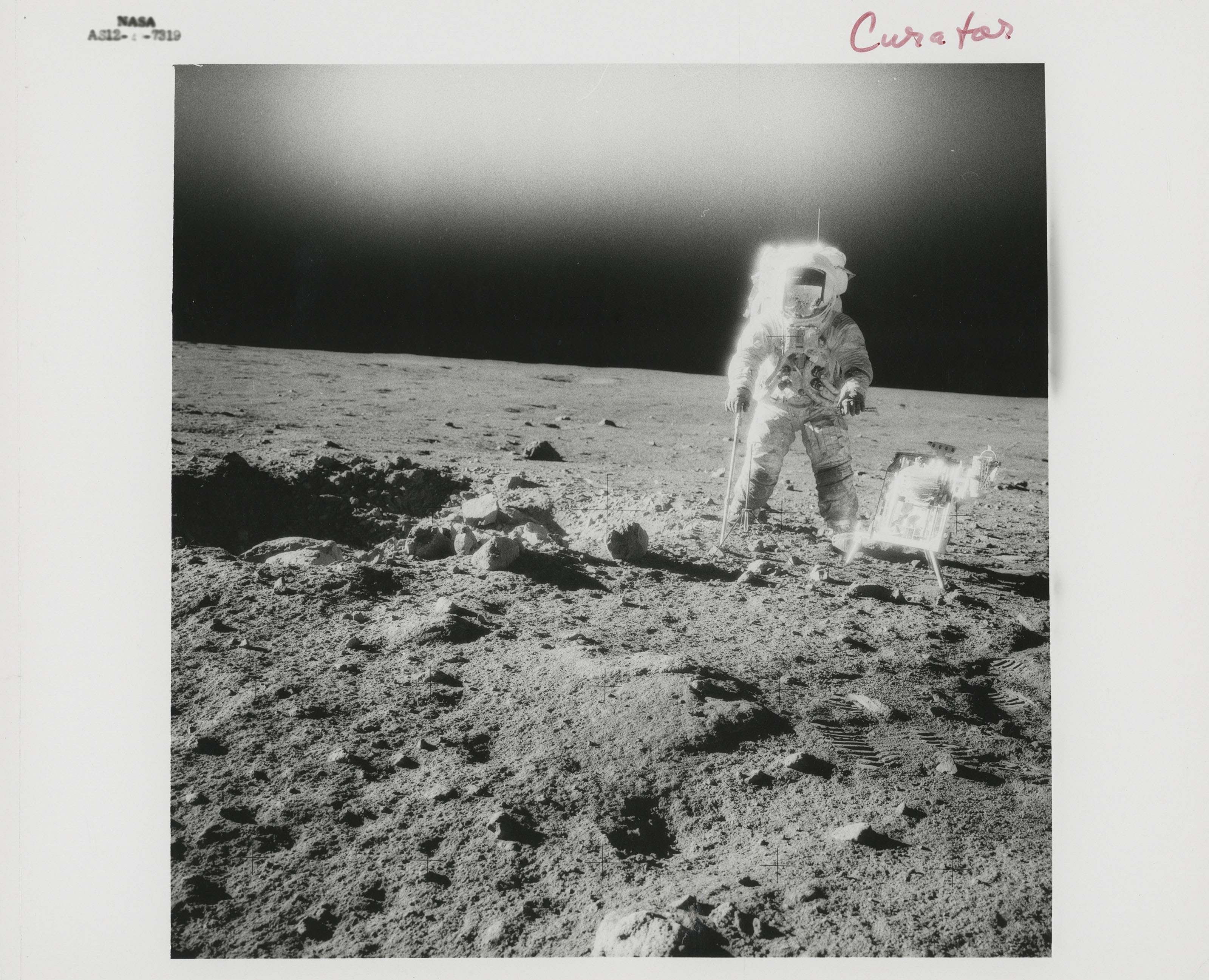 Portraits of Pete Conrad on the rim of Surveyor Crater; the gnomon and ...