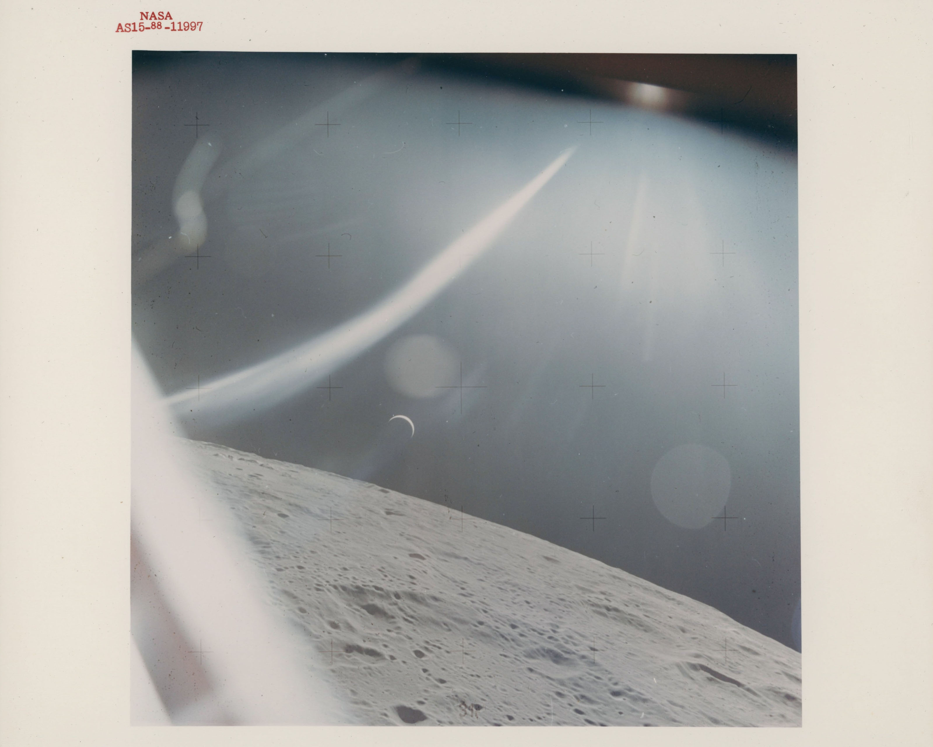 Wide angle view of the Earth rising above the lunar horizon, with ...
