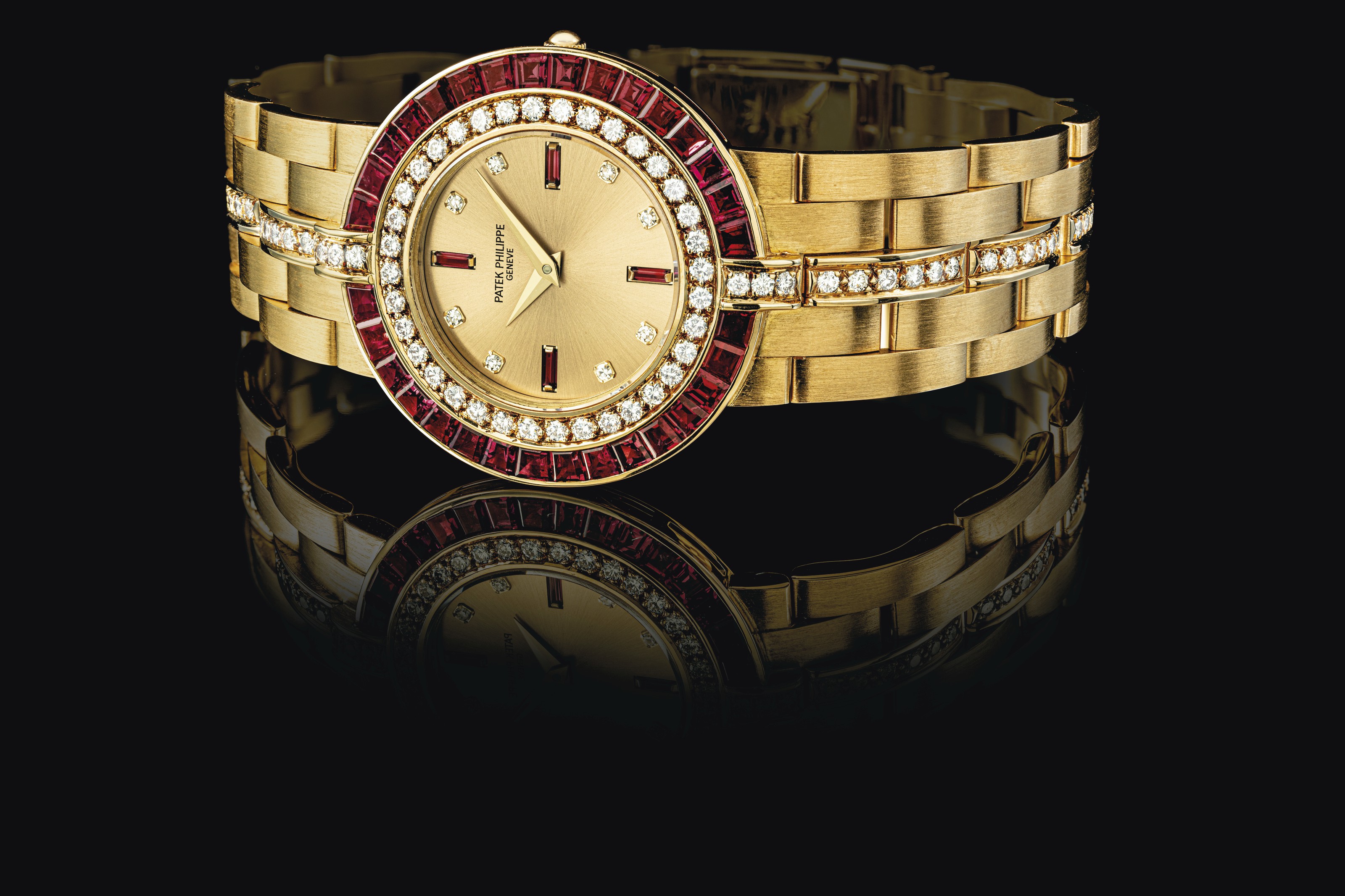 PATEK PHILIPPE. AN 18K GOLD, DIAMOND AND RUBY-SET BRACELET WATCH