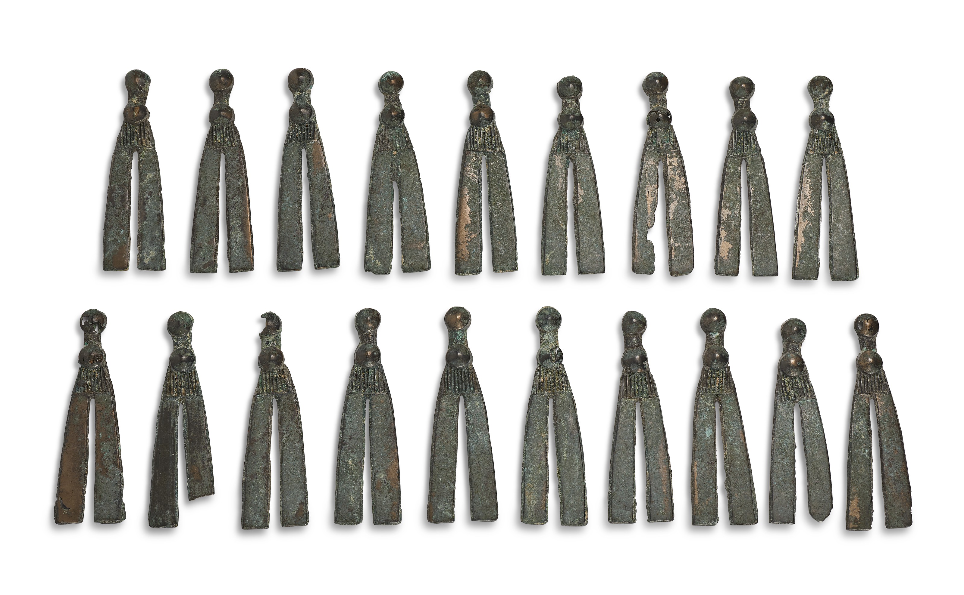 A GROUP OF THIRTY-FOUR BRONZE V-SHAPED HARNESS ORNAMENTS, INNER ...