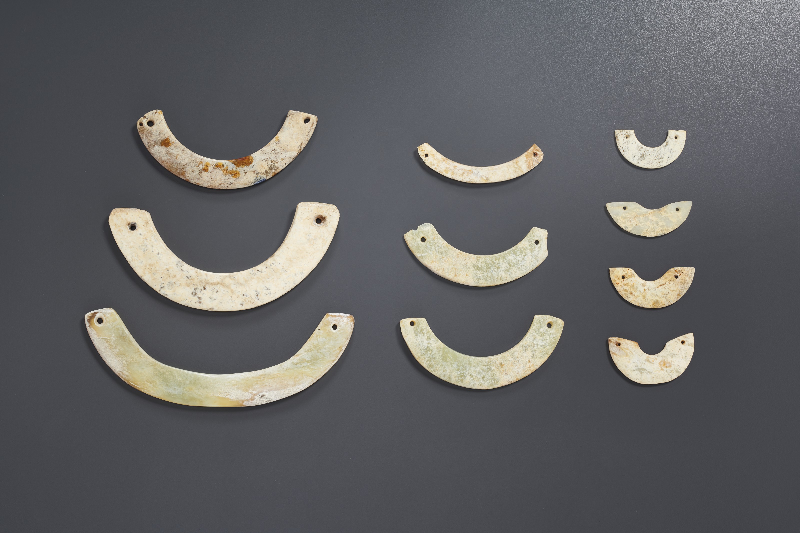 TEN MOTTLED SEMI-TRANSLUCENT ALTERED OLIVE-GREEN JADE ARC-SHAPED ...