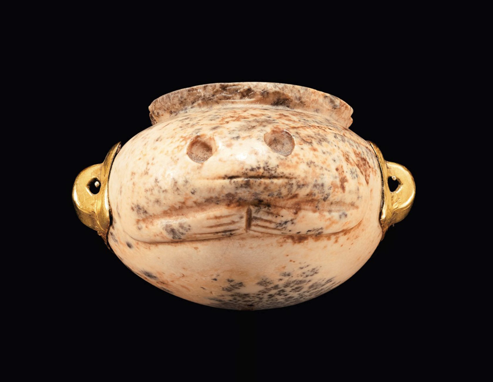 AN EGYPTIAN MOTTLED LIMESTONE AND GOLD FROG VESSEL