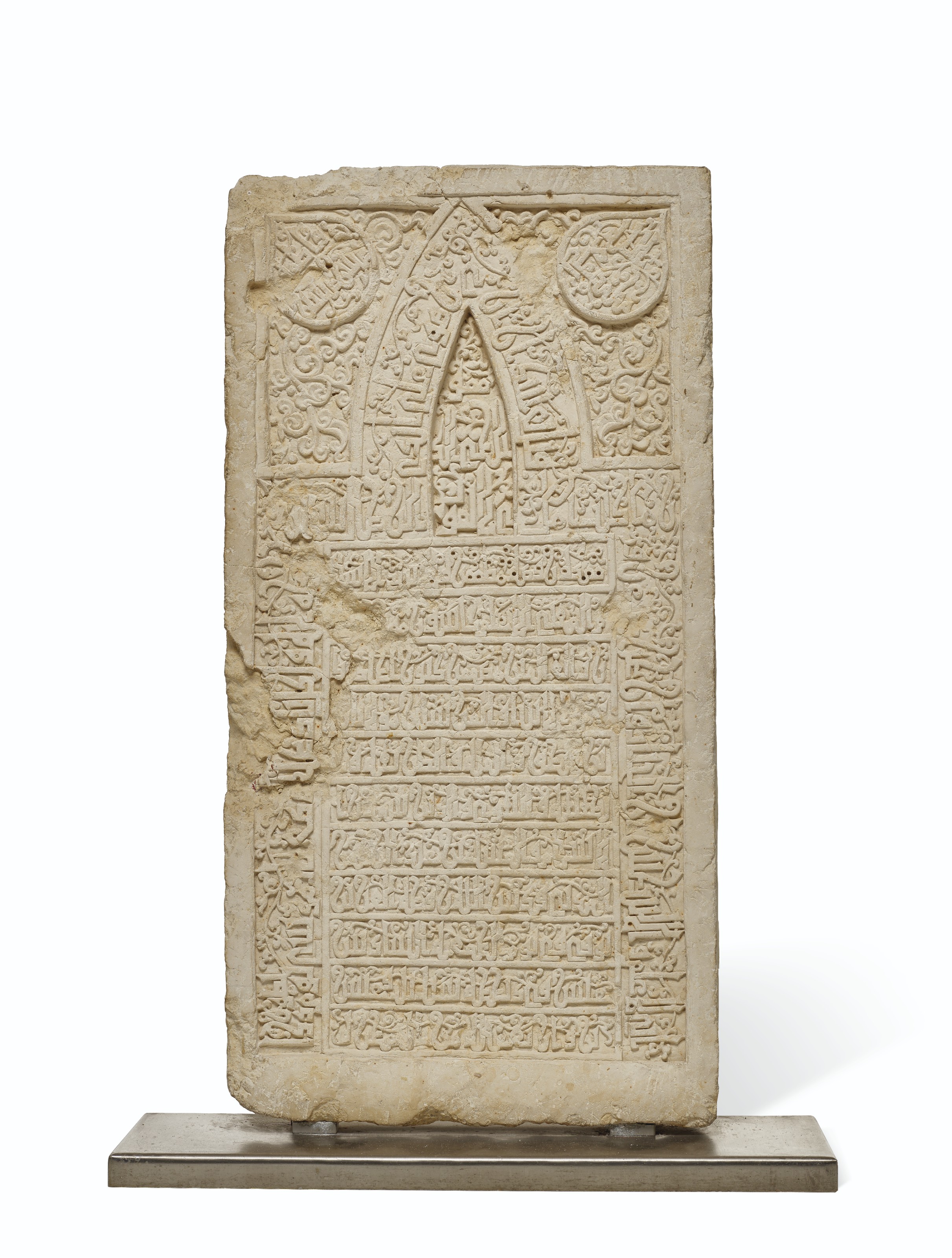 A CARVED WHITE LIMESTONE TOMBSTONE