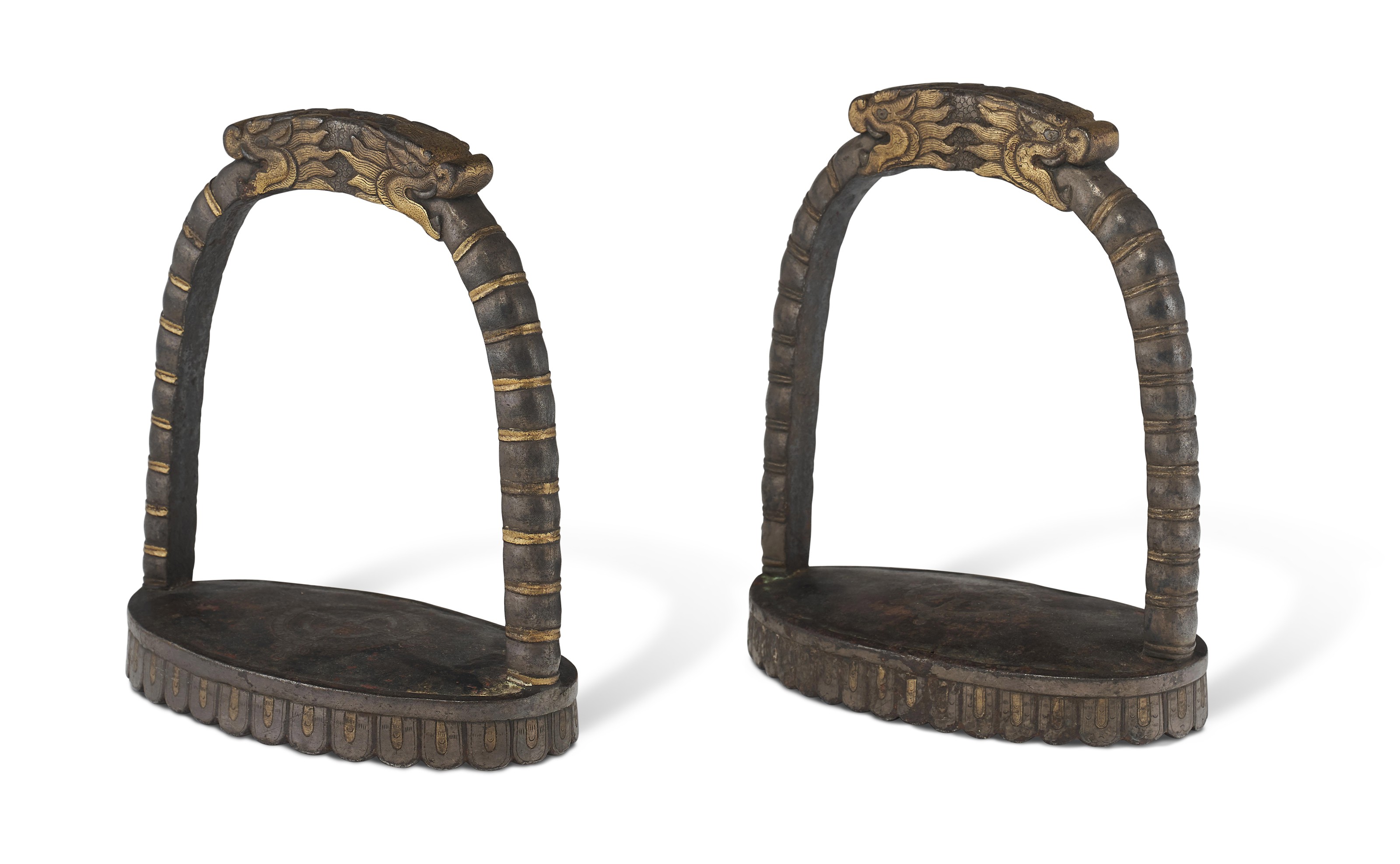 A PAIR OF SILVER-AND GILT-DAMASCENED IRON STIRRUPS, TIBET, 17TH CENTURY ...