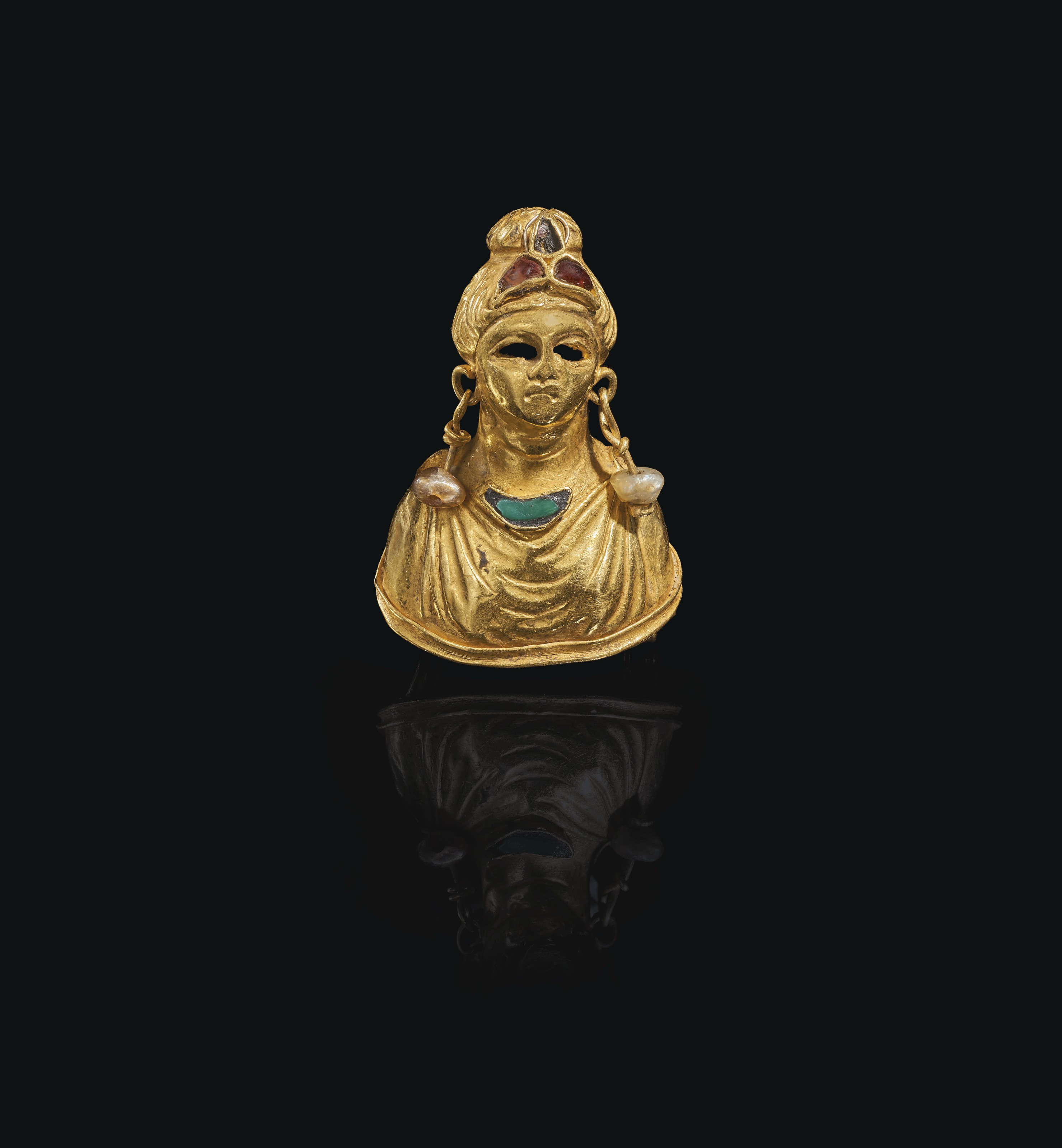 A BACTRIAN GOLD, GARNET PEARL AND TURQUOISE FEMALE BUST, CIRCA 1ST ...
