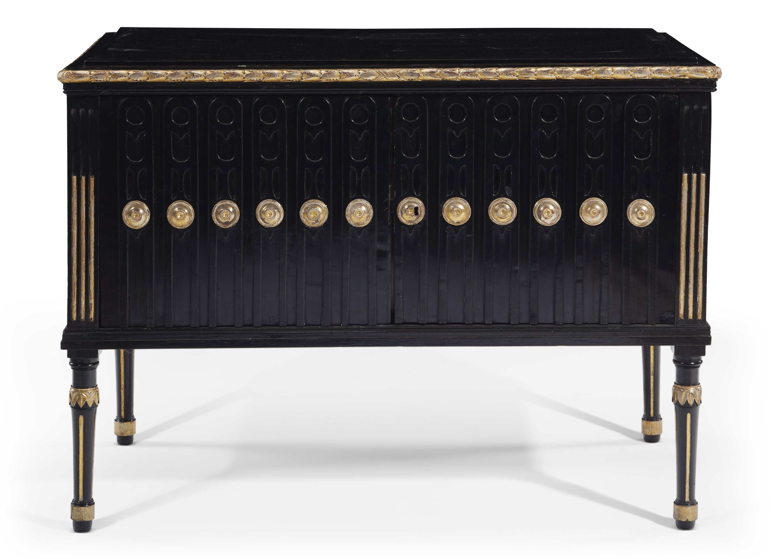 A NORTHERN EUROPEAN EBONIZED AND PARCEL-GILT DOUBLE DOOR COMMODE ...