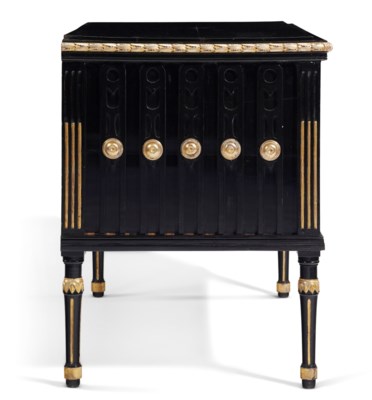 A NORTHERN EUROPEAN EBONIZED AND PARCEL-GILT DOUBLE DOOR COMMODE ...