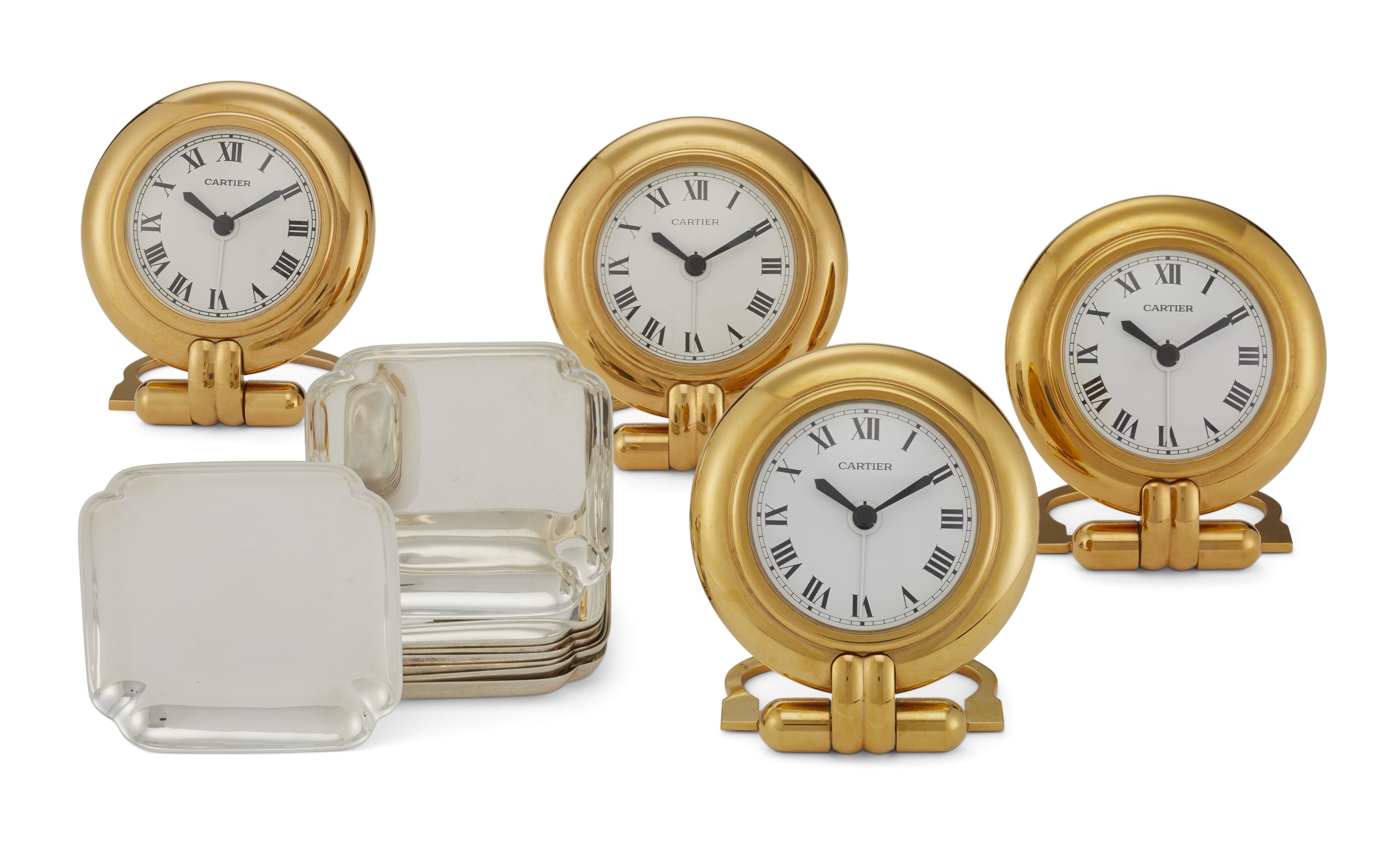 A SET OF FOUR GILT-METAL TABLE CLOCKS AND A SET OF EIGHT SILVER ...