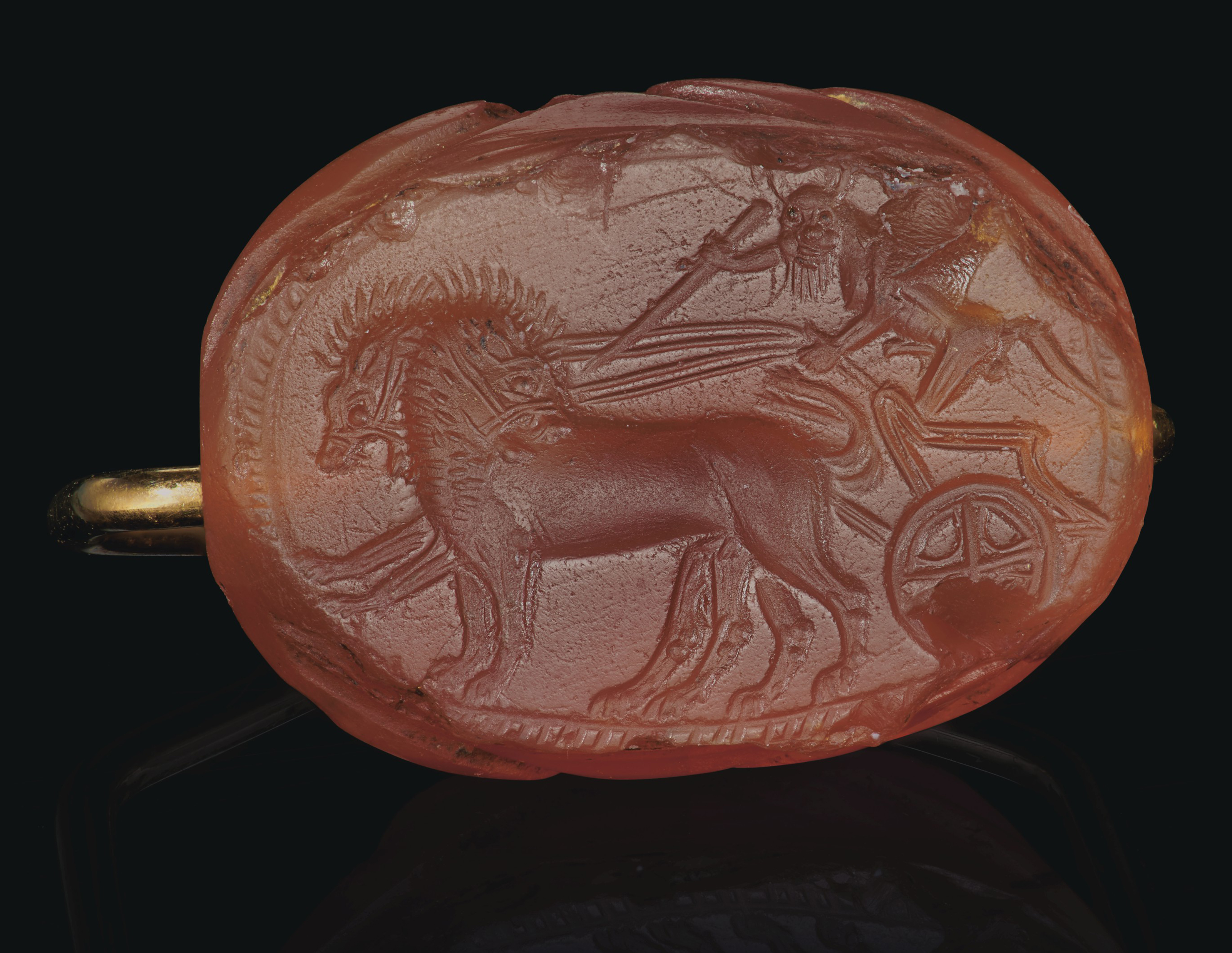 A GREEK CARNELIAN SCARAB WITH A SATYR DRIVING A LION BIGA, ATTRIBUTED ...