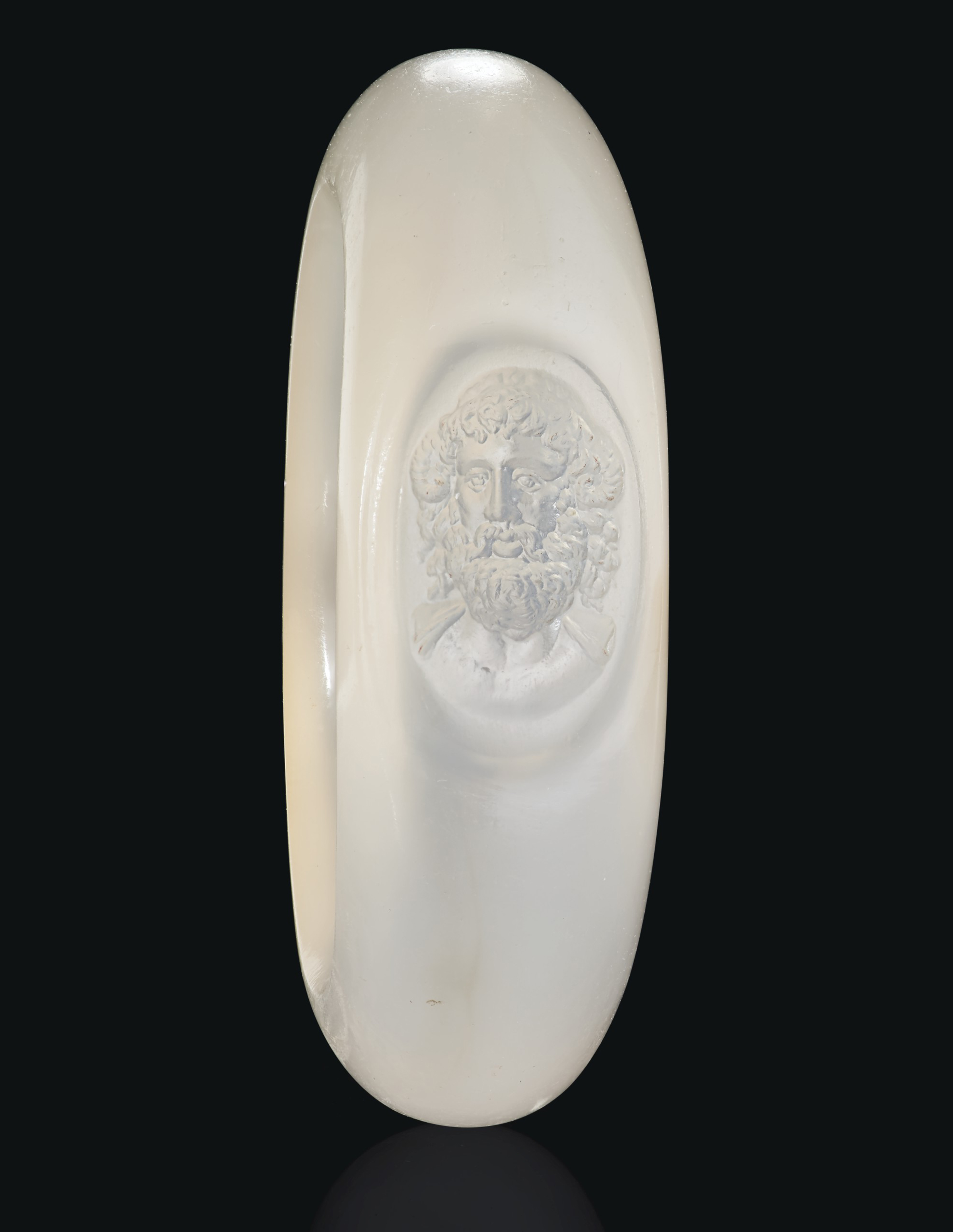 A ROMAN GREY CHALCEDONY FINGER RING WITH JUPITER AMMON, CIRCA 1ST-2ND ...