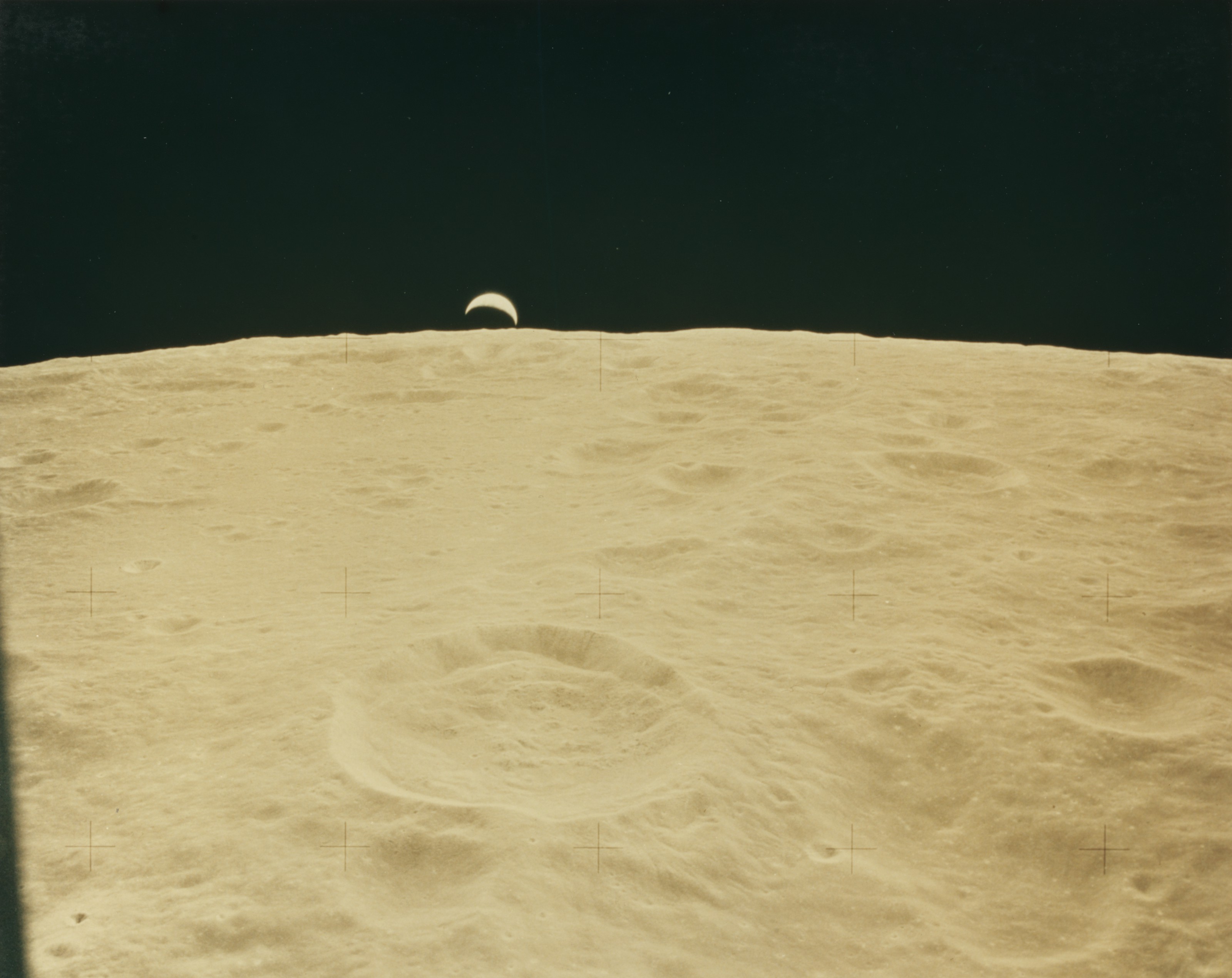 Crescent Earth emerging over the lunar horizon; crescent Earthrise ...
