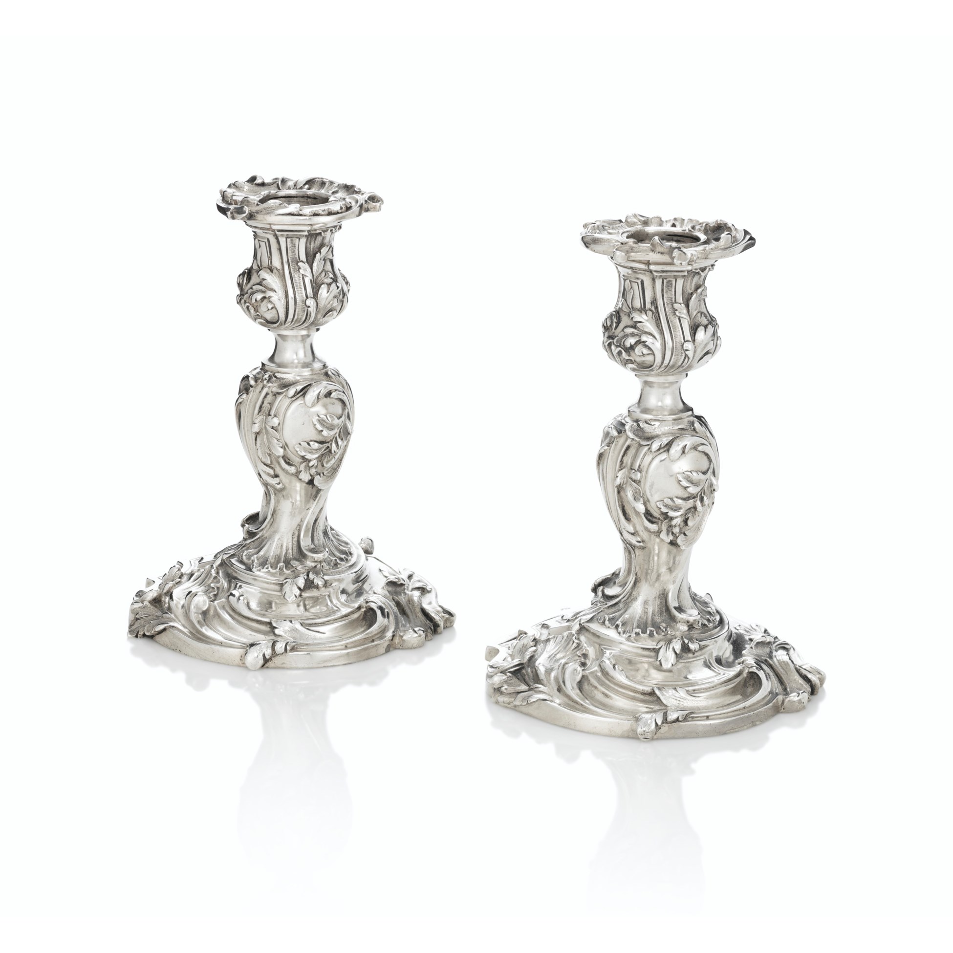 A PAIR OF SILVER CANDLESTICKS