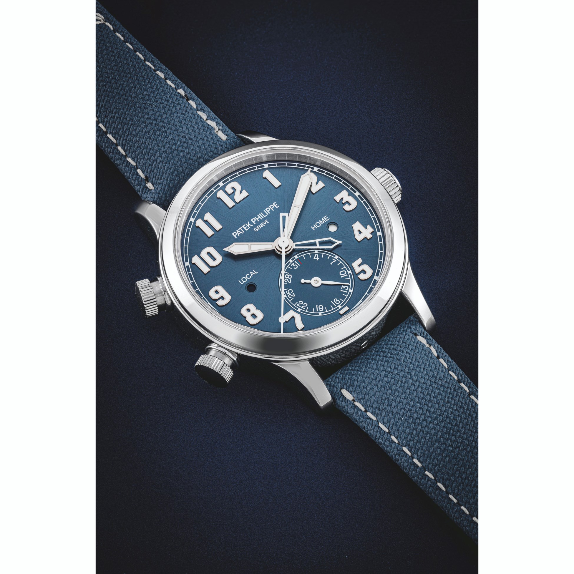 PATEK PHILIPPE. A RARE STAINLESS STEEL LIMITED EDITION AUTOMATIC DUAL ...