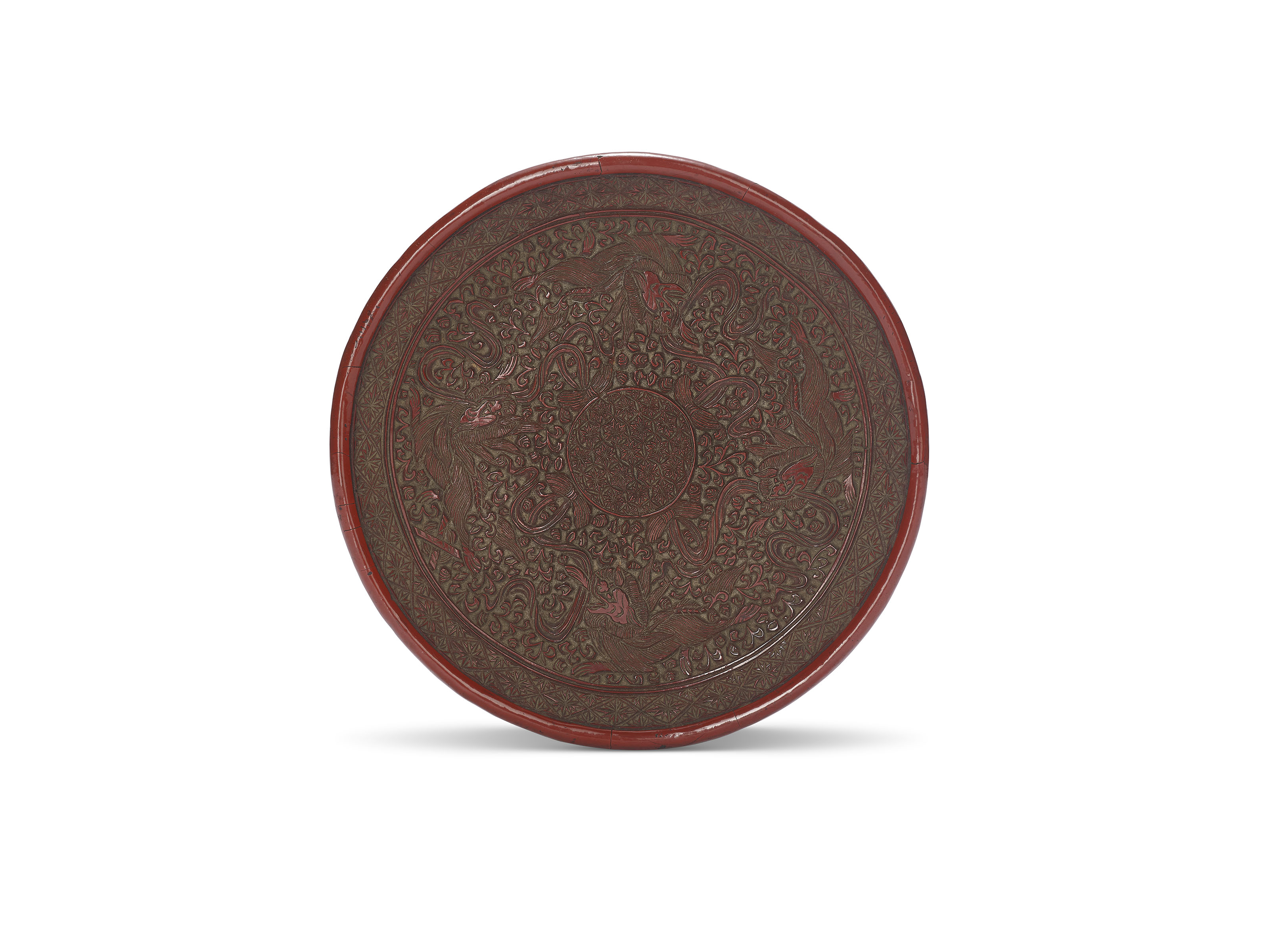 A CARVED CINNABAR LACQUER ‘BUDDHIST LIONS’ DISH, MING DYNASTY (1368 ...