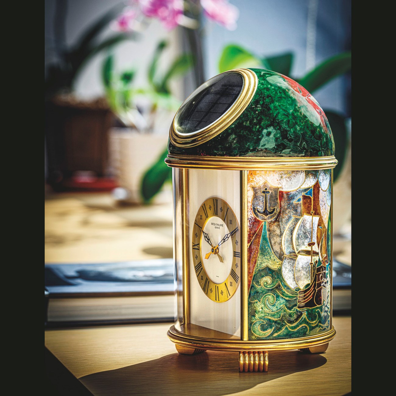 PATEK PHILIPPE. A UNIQUE GILT BRASS SOLAR POWERED DOME CLOCK WITH ...