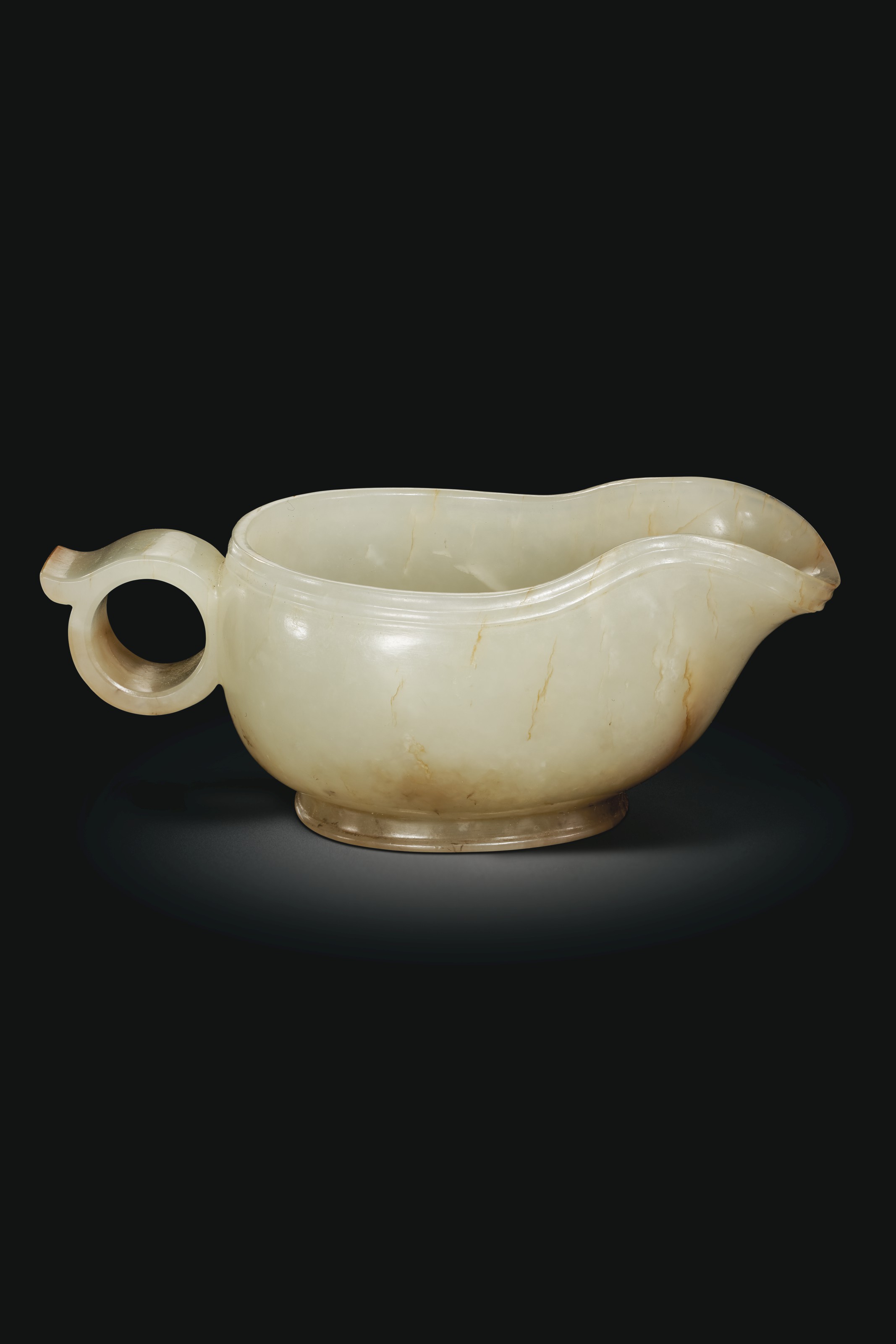 A BEIGE AND PALE RUSSET JADE OVAL CUP WITH HANDLE, MING DYNASTY (1368 ...