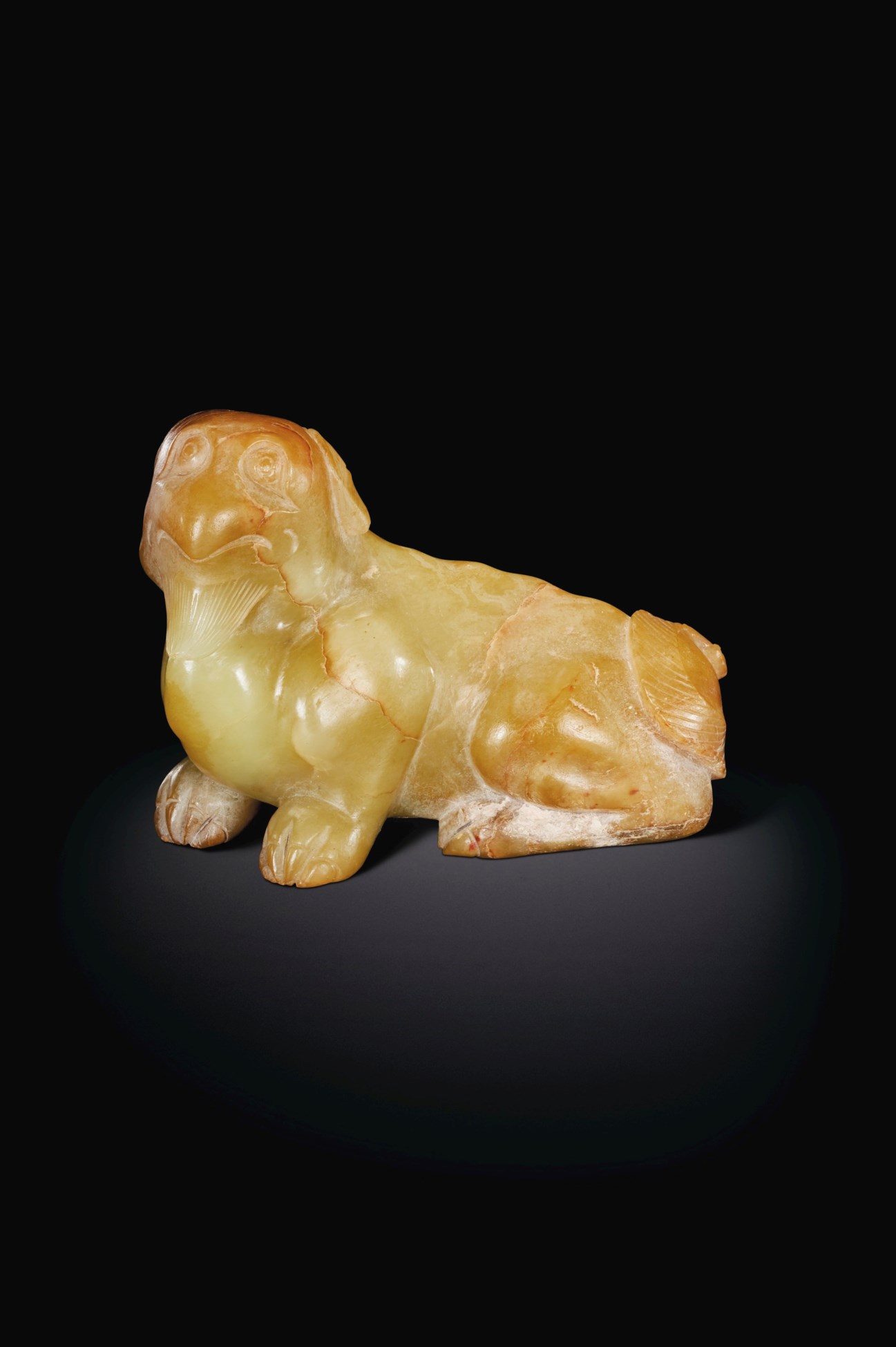 A YELLOW AND PALE RUSSET JADE FIGURE OF A MYTHICAL BEAST, MING DYNASTY ...