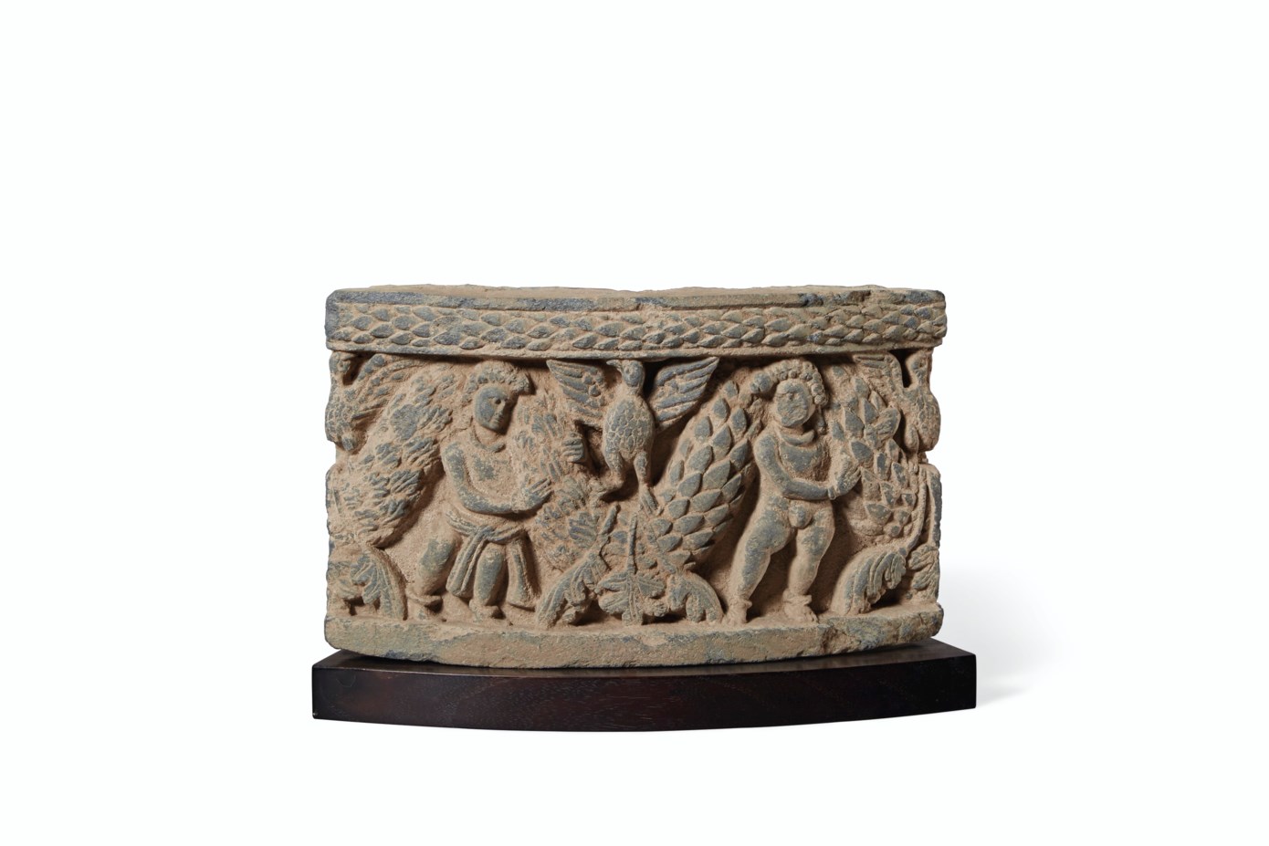 A GRAY SCHIST RELIEF DEPICTING GARLAND BEARERS, ANCIENT REGION OF ...
