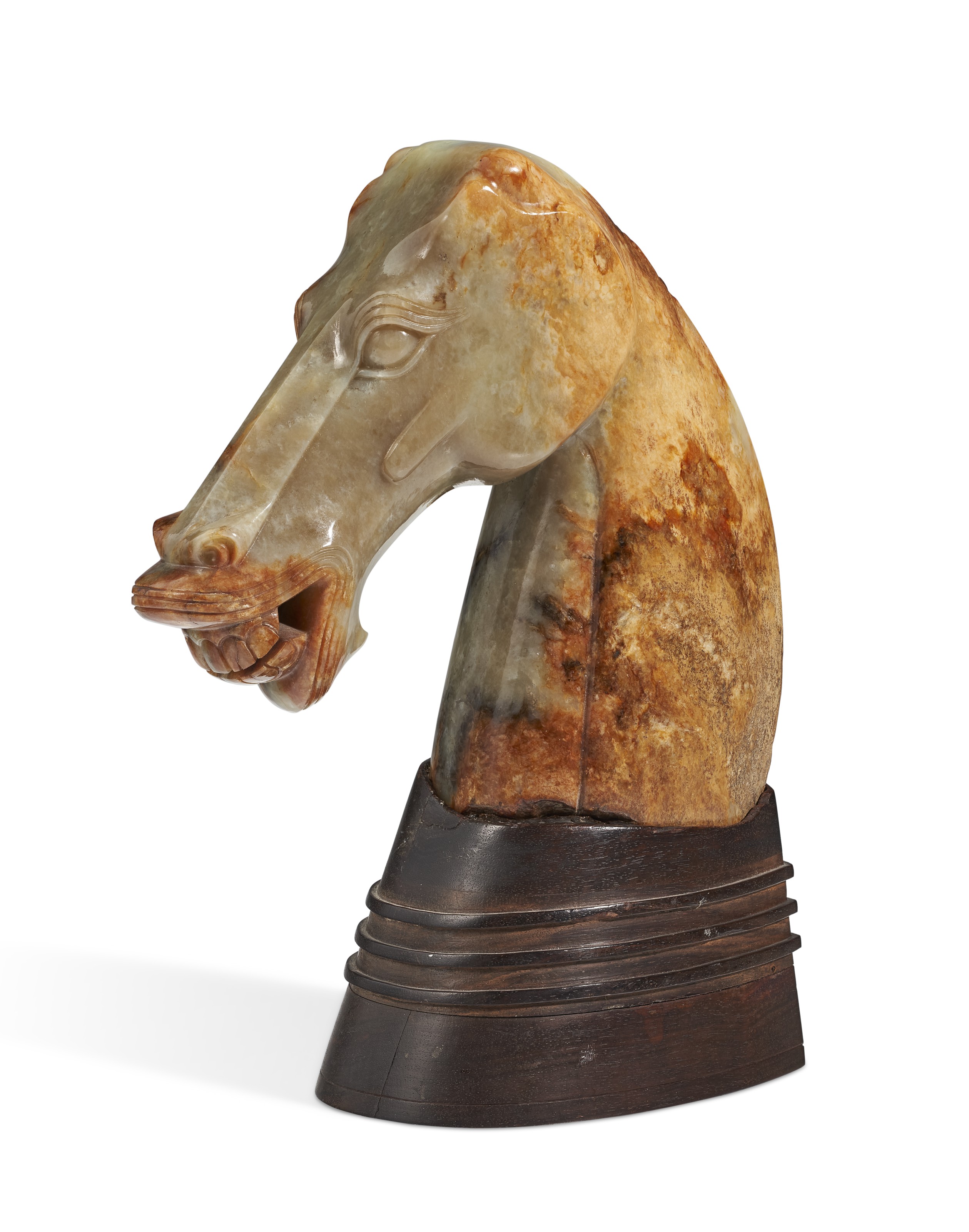 A RUSSET AND PALE GREEN JADE HAN-STYLE HORSE HEAD, | Christie’s