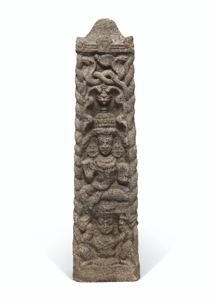 A GRANITE PILLAR WITH A YAKSHA AND SNAKES, SOUTH INDIA, KARNATAKA, 13TH ...