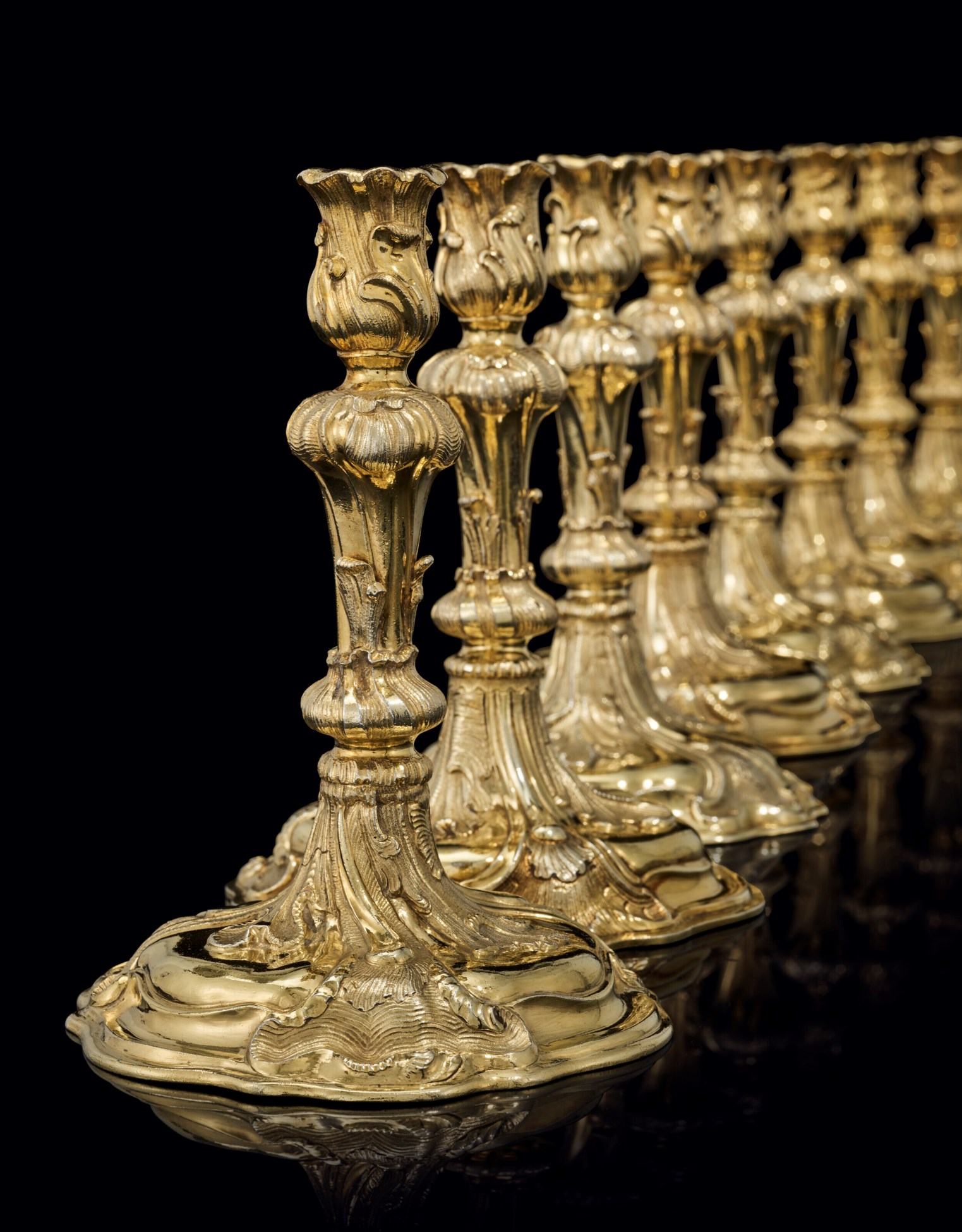 A SET OF EIGHT ROYAL GERMAN SILVER-GILT CANDLESTICKS FROM THE ELECTOR ...