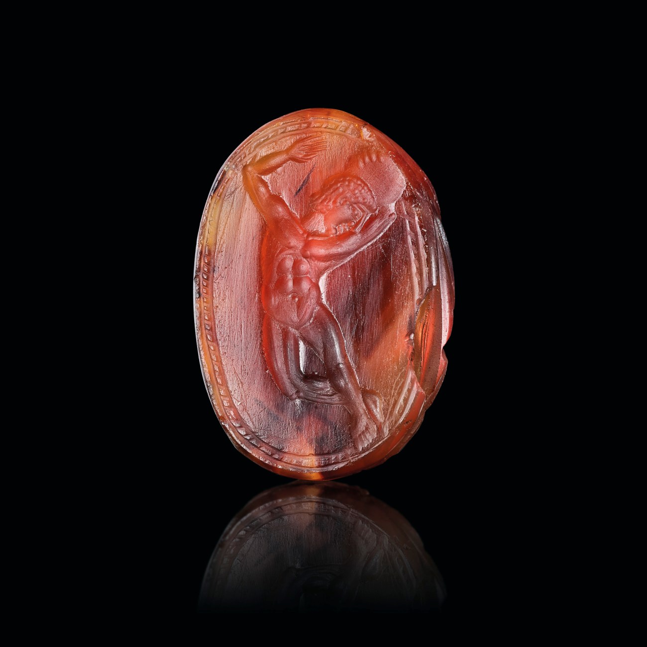 A GREEK CARNELIAN SCARAB WITH AN ATHLETE HOLDING A DISCUS, ARCHAIC ...