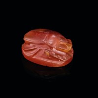 A GREEK CARNELIAN SCARAB WITH A YOUTH LEANING ON A STAFF, ARCHAIC ...