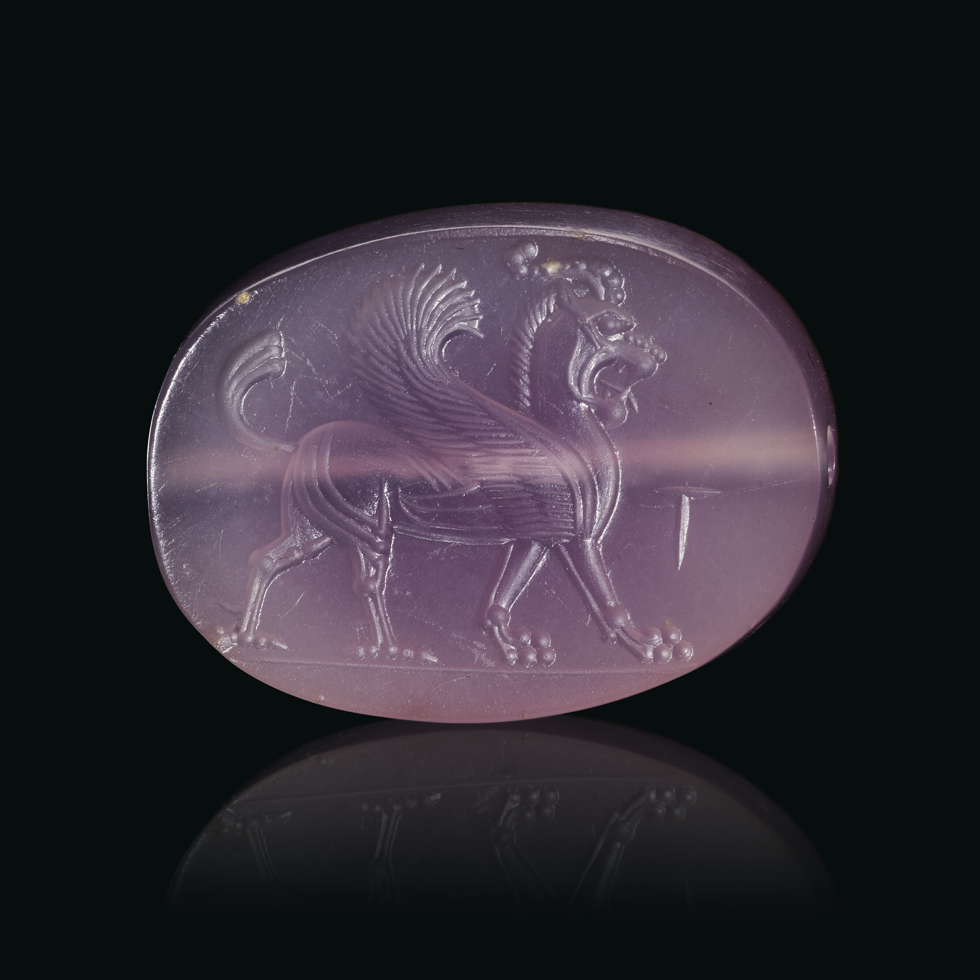 A GREEK CARNELIAN SCARAB WITH A YOUTH LEANING ON A STAFF, ARCHAIC ...