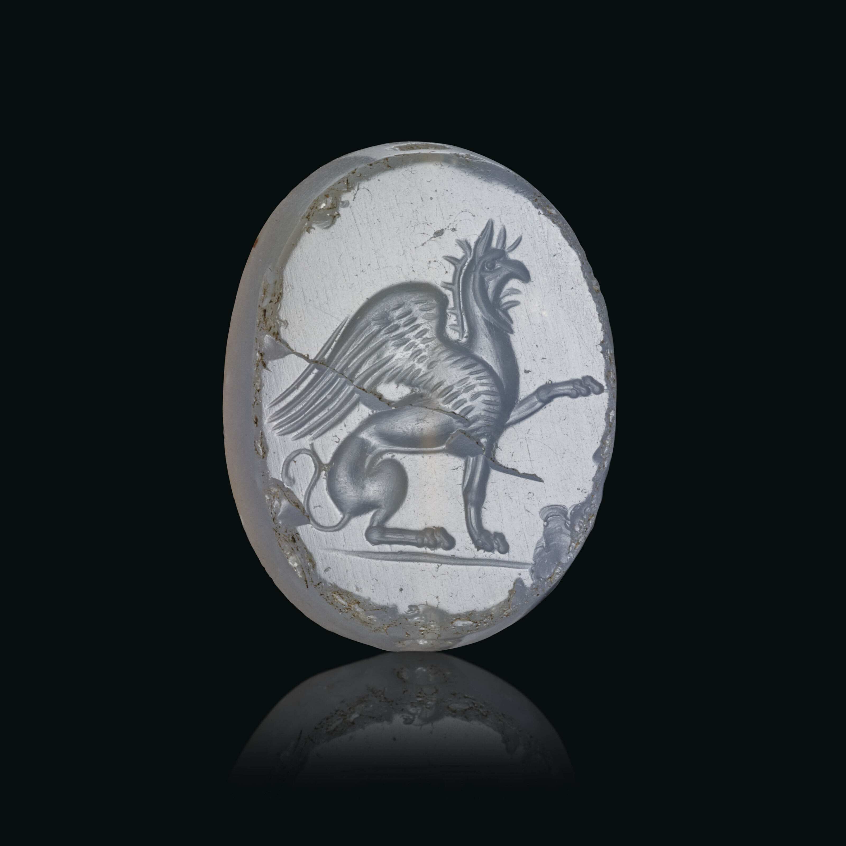 A GREEK CARNELIAN SCARAB WITH A YOUTH LEANING ON A STAFF, ARCHAIC ...