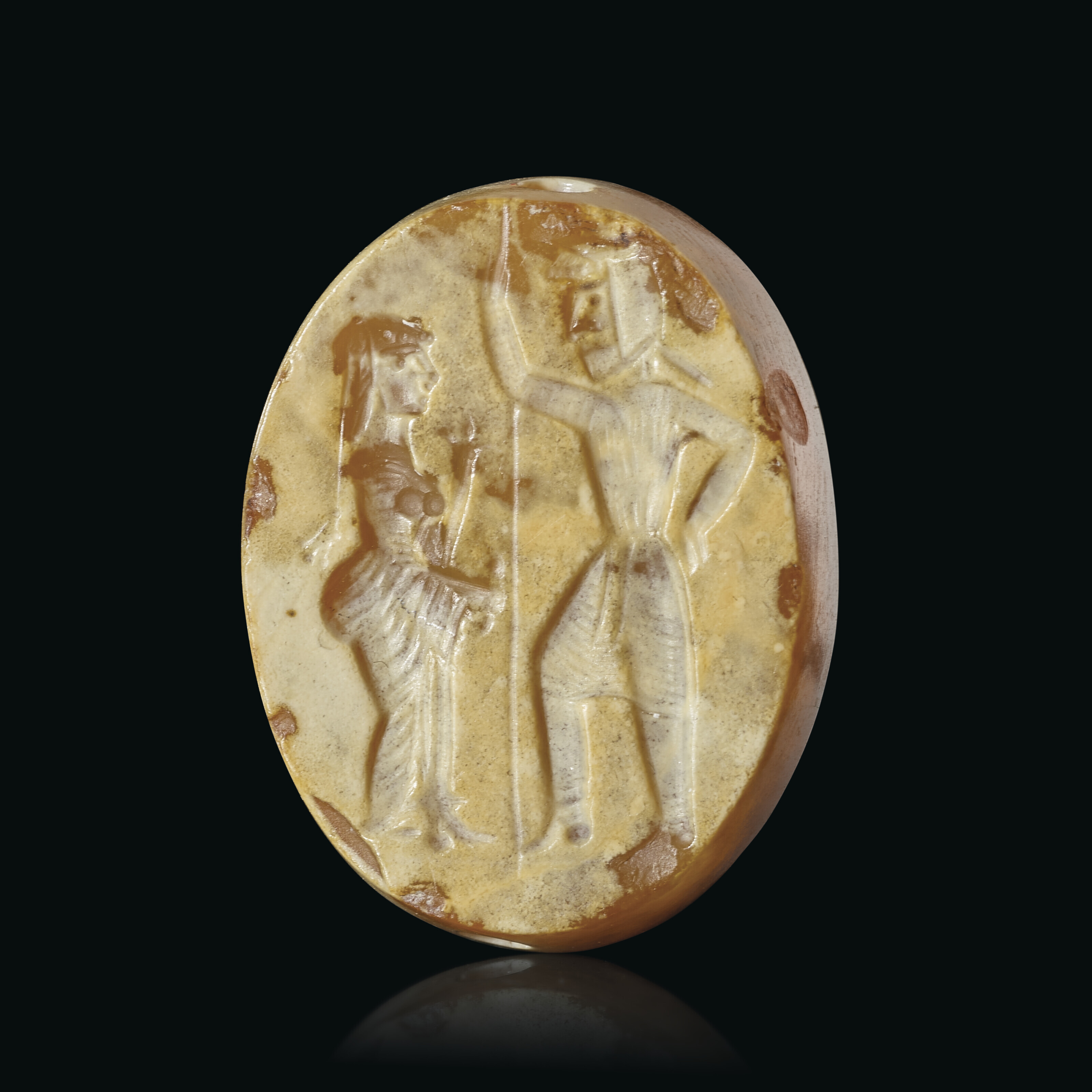 A GREEK CARNELIAN SCARAB WITH A YOUTH LEANING ON A STAFF, ARCHAIC ...