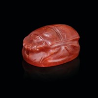 AN ETRUSCAN CARNELIAN SCARAB WITH HERCLE ON A RAFT