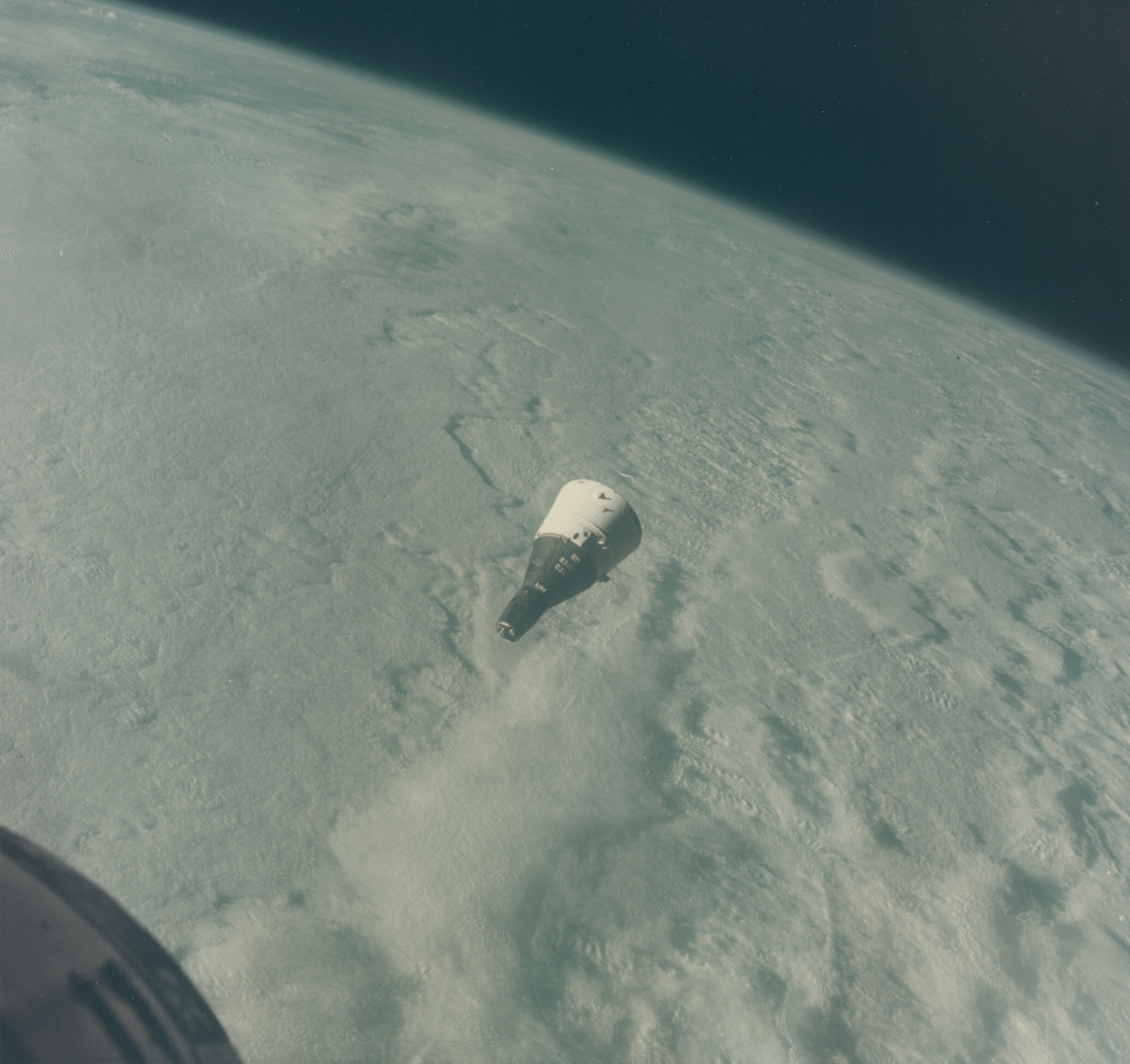 GEMINI VII SPACECRAFT ABOVE THE CLOUD-COVERED EARTH, DECEMBER 15, 1965 ...