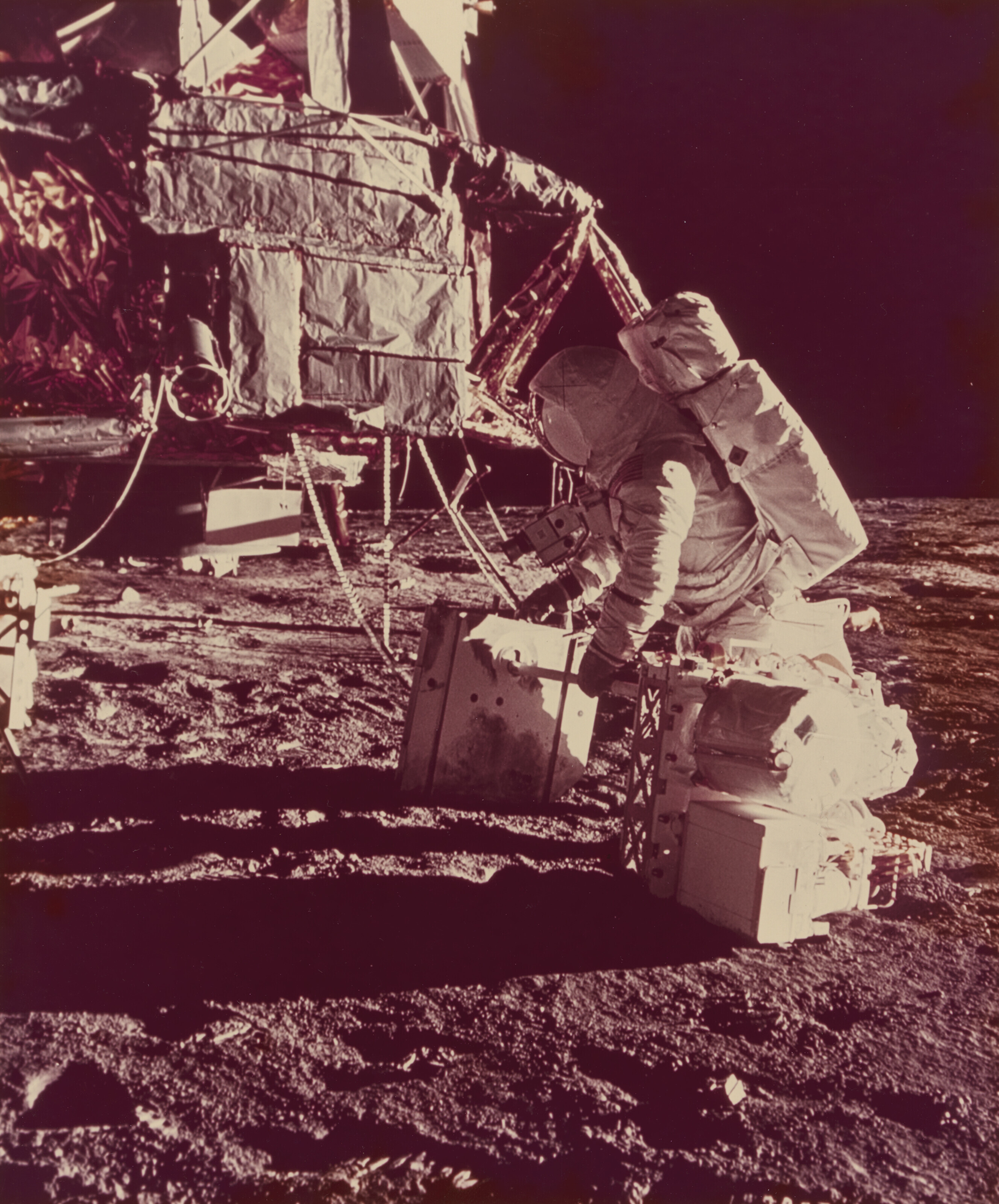 VIEWS OF ALAN BEAN PREPARING TO CARRY THE SCIENTIFIC EQUIPMENT ...