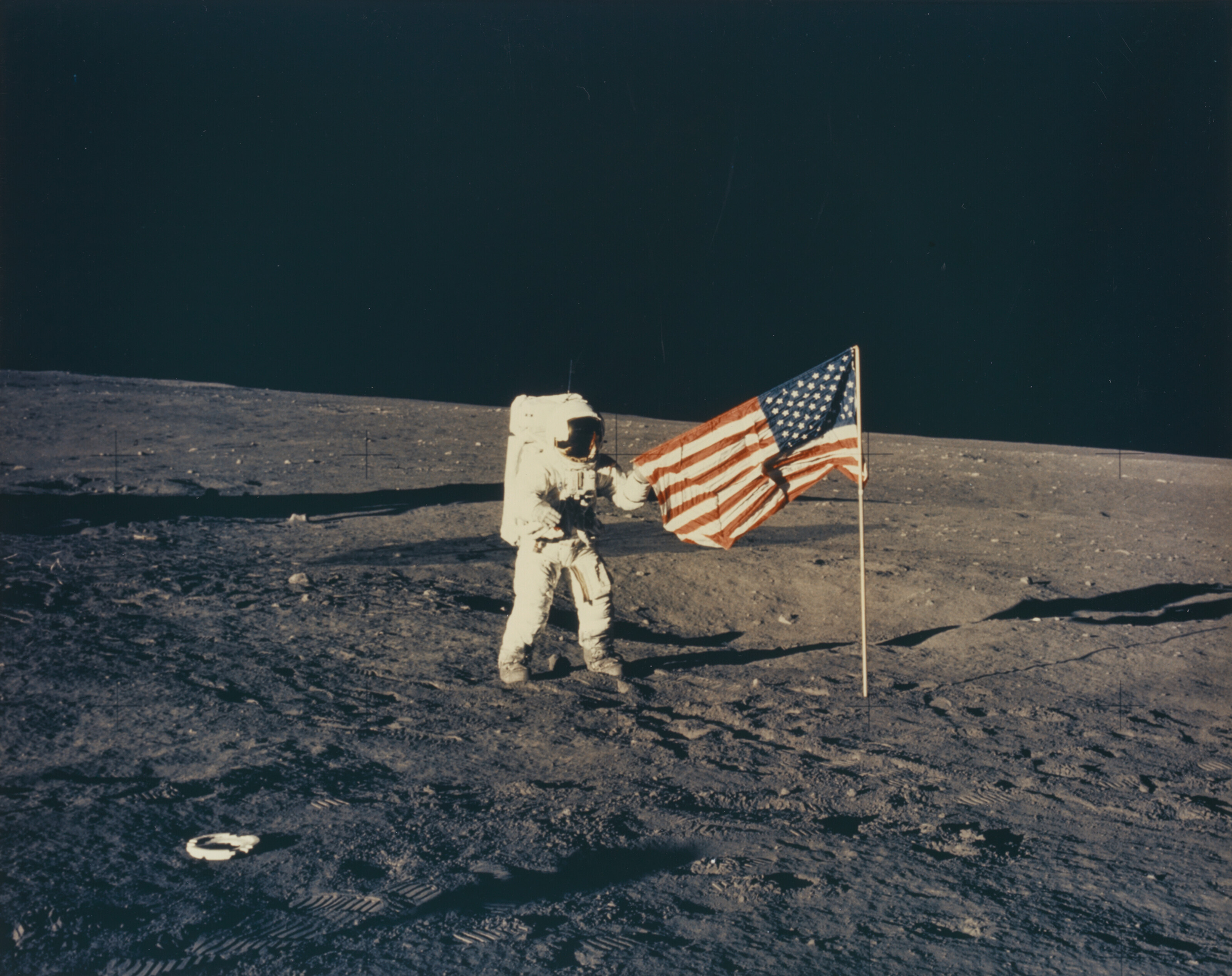 PETE CONRAD HOLDING THE U.S. FLAG ON THE OCEAN OF STORMS, NOVEMBER 19 ...