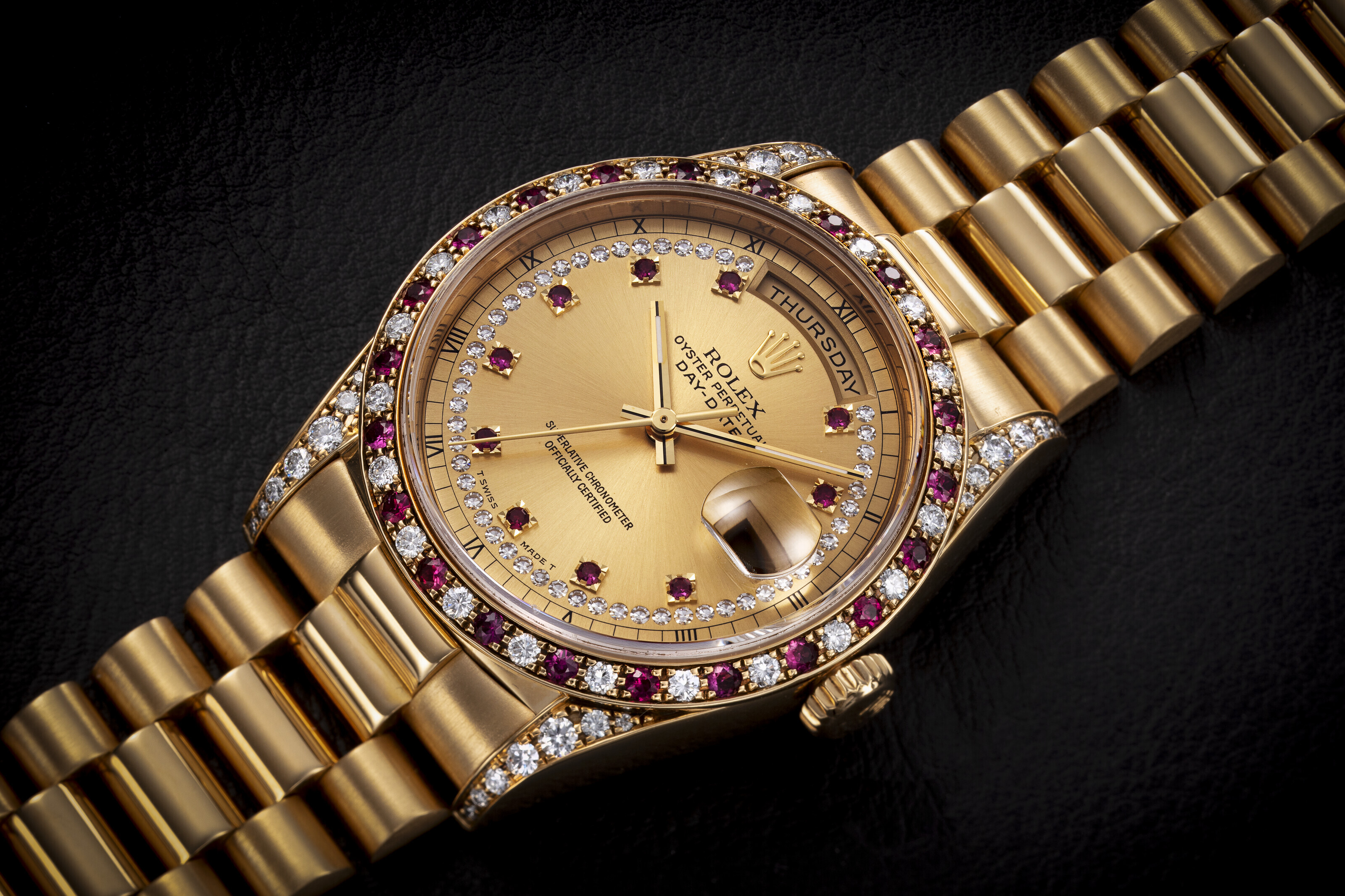 ROLEX, DAY-DATE REF. 18388, A RARE GOLD, DIAMOND AND RUBY-SET AUTOMATIC ...