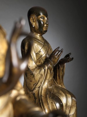 AN EXCEEDINGLY RARE PAIR OF GILT-BRONZE SEATED LUOHAN FIGURES, YUAN ...