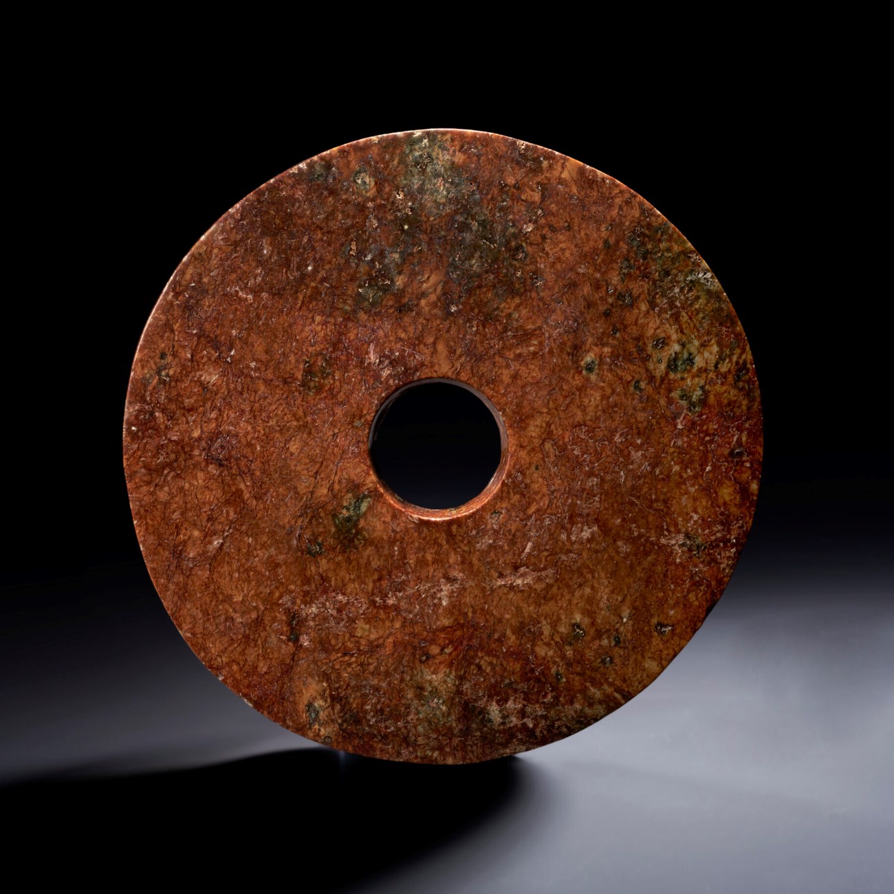 A LARGE REDDISH-BROWN JADE BI DISC, NEOLITHIC PERIOD, LIANGZHU CULTURE ...