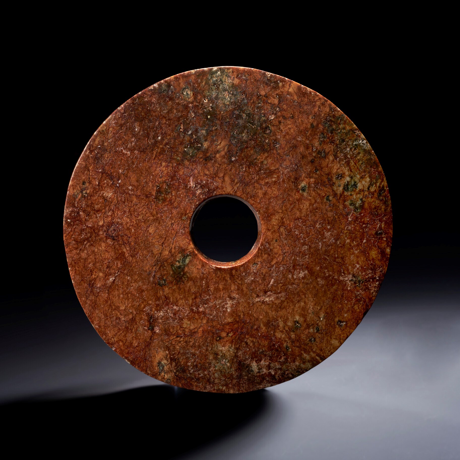 A LARGE REDDISH-BROWN JADE BI DISC, NEOLITHIC PERIOD, LIANGZHU CULTURE ...