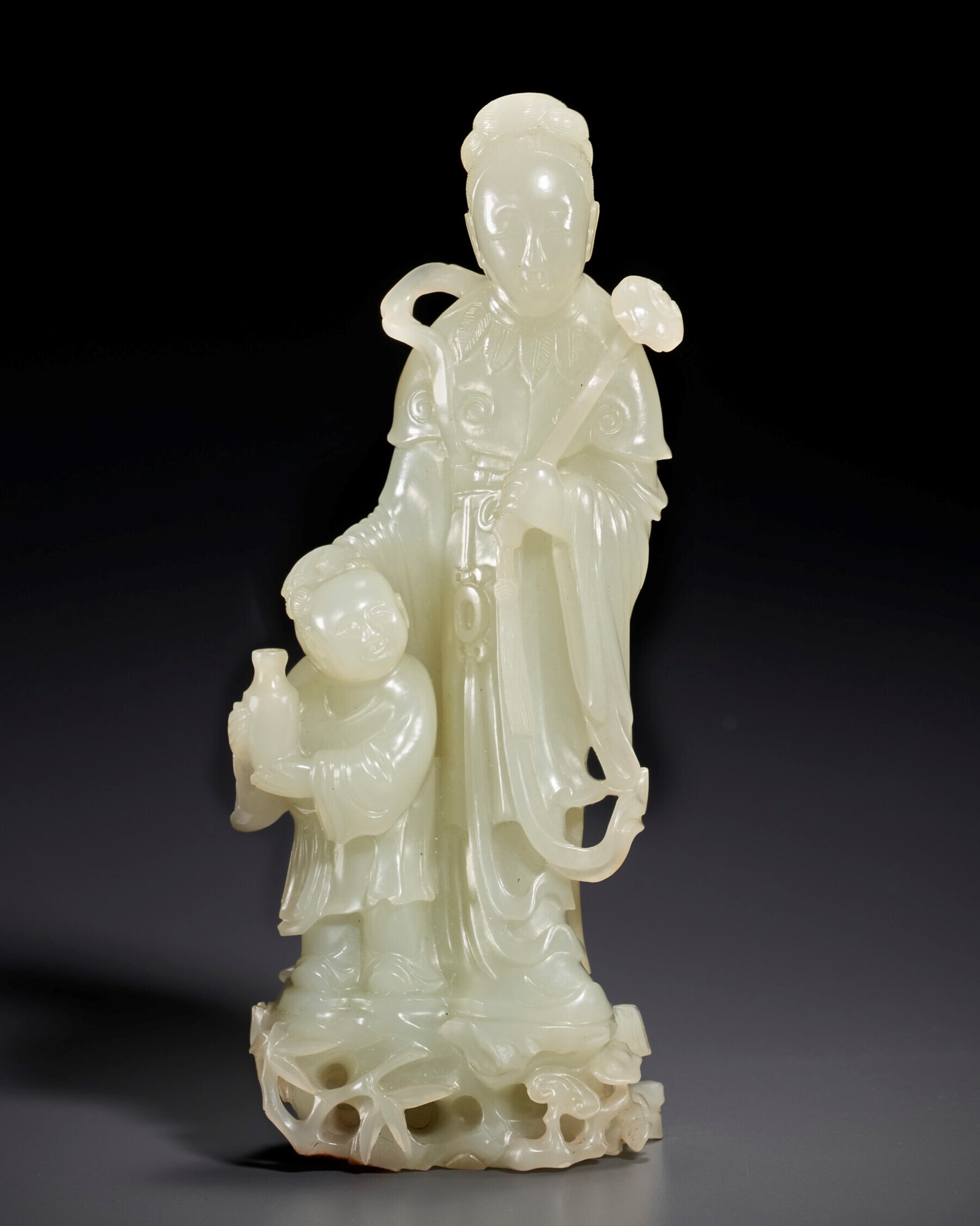A FINELY CARVED WHITE JADE FIGURE OF A FEMALE IMMORTAL AND ATTENDANT ...