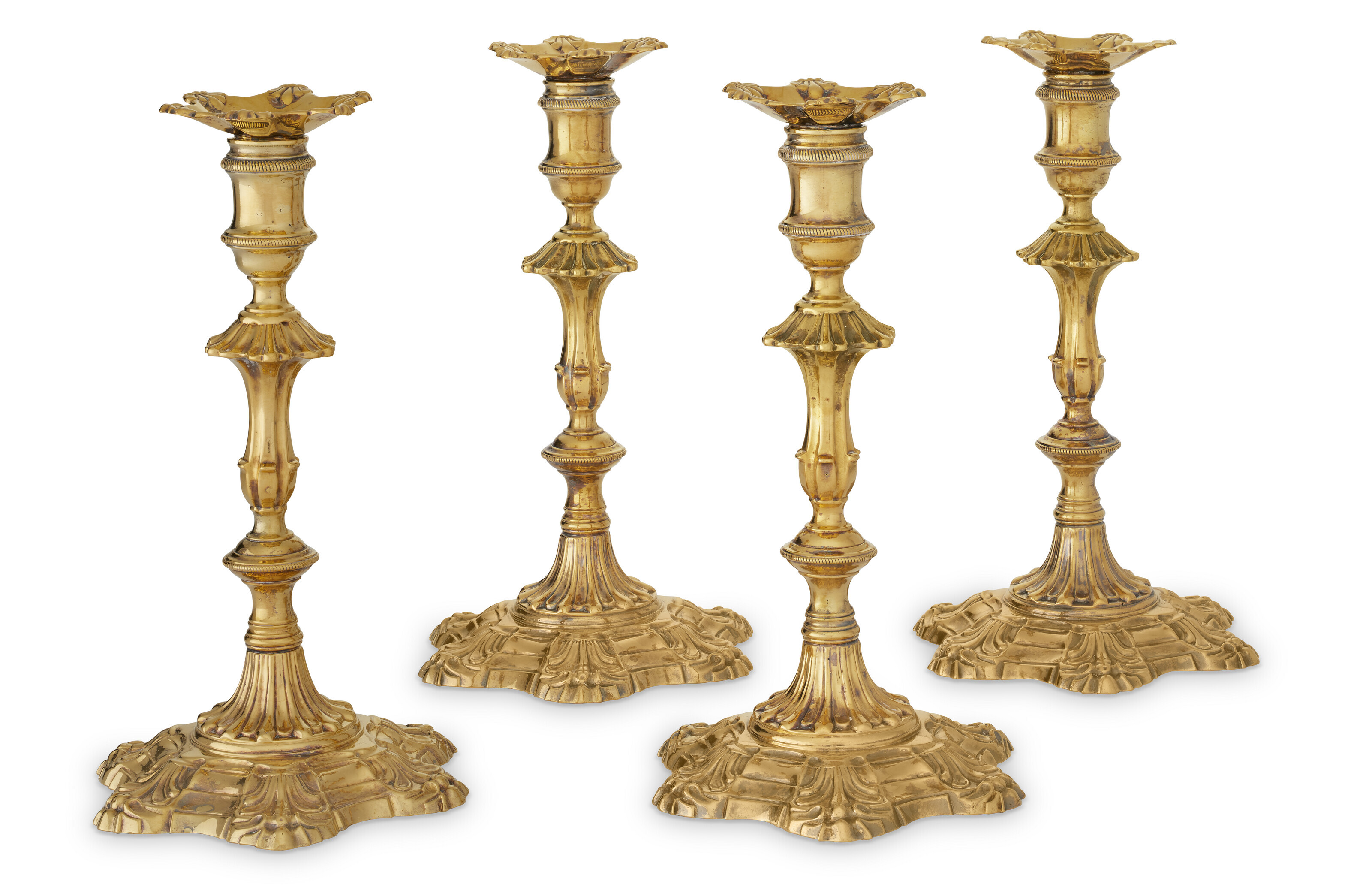 A SET OF FOUR GEORGE II SILVER-GILT CANDLESTICKS, MARK OF JOHN PRIEST ...