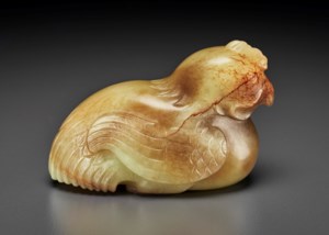 A YELLOWISH-BEIGE JADE FIGURE OF A RECUMBENT HEN, MING DYNASTY (1368 ...