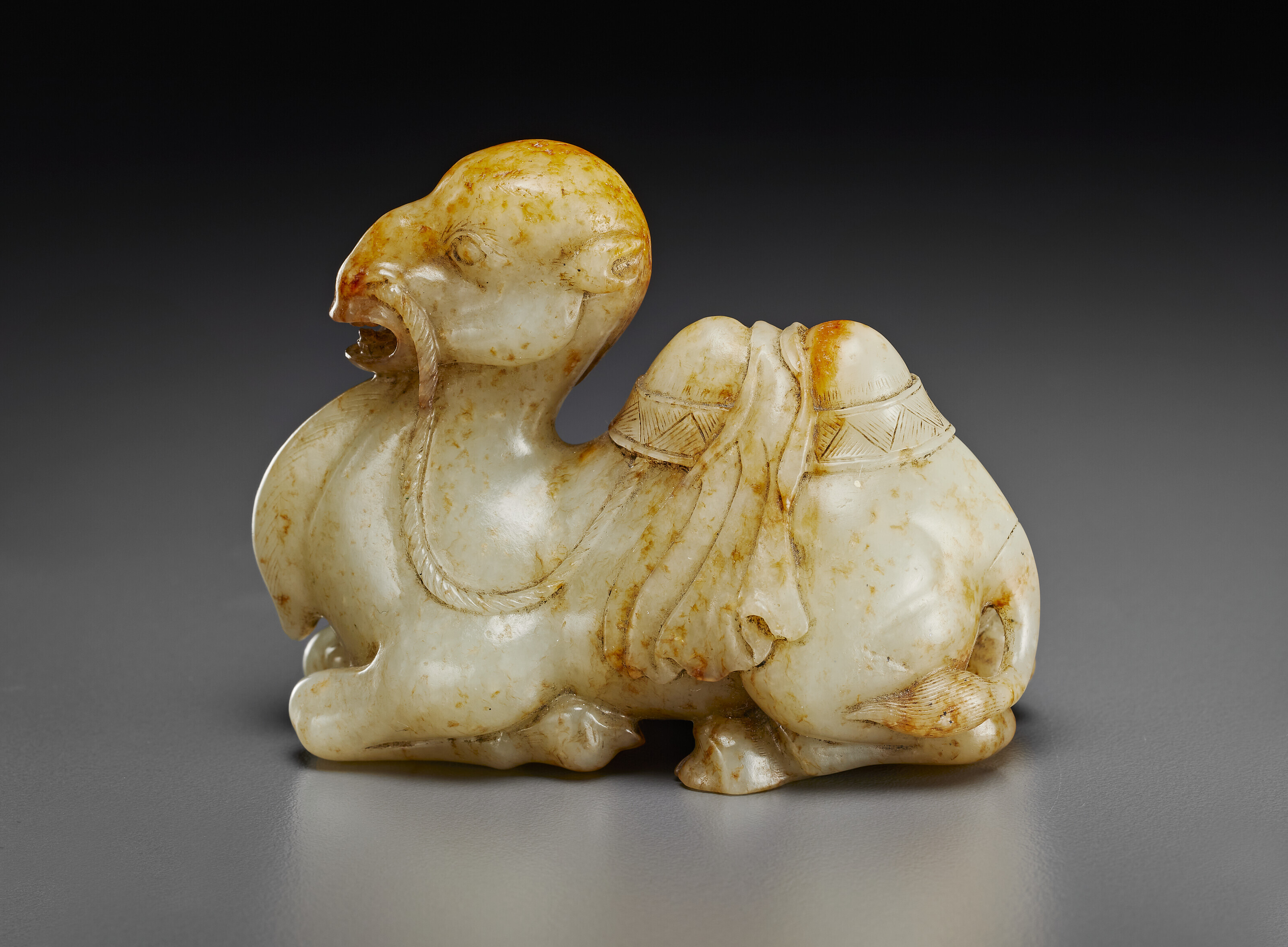 A YELLOW AND RUSSET JADE FIGURE OF A GOOSE, MING DYNASTY (1368-1644 ...