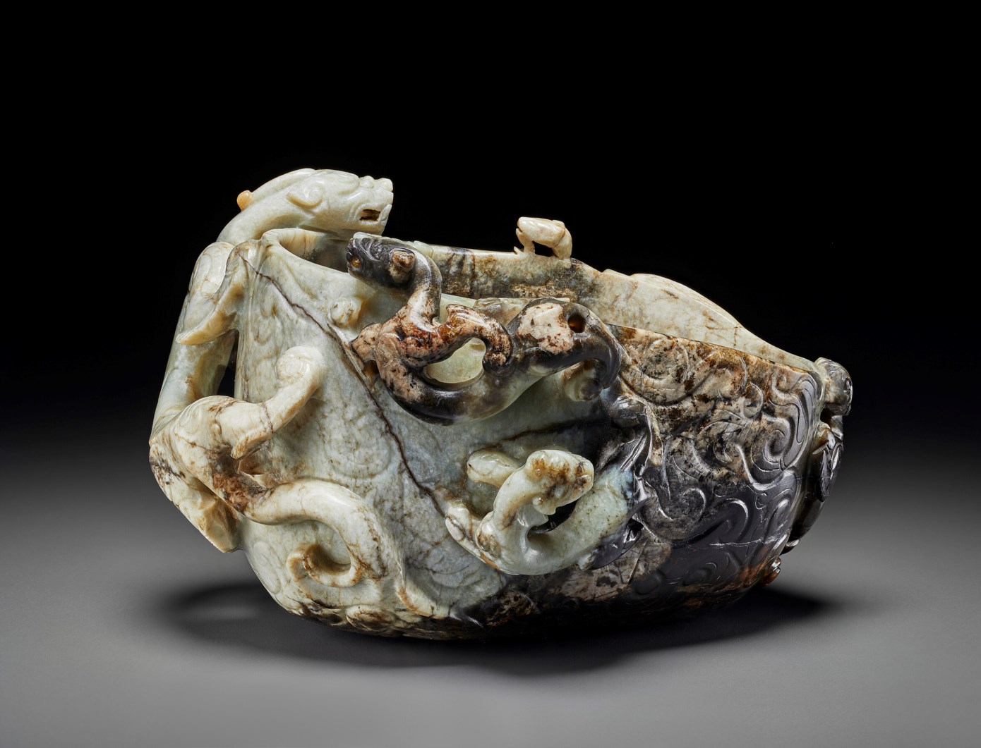 A MOTTLED `CHICKEN-BONE' JADE LIBATION VESSEL, LATE MING-QING DYNASTY ...