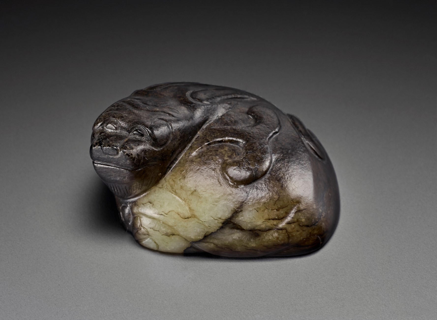 A BLACK AND GREENISH-GREY JADE FIGURE OF A MYTHICAL BEAST , MING ...