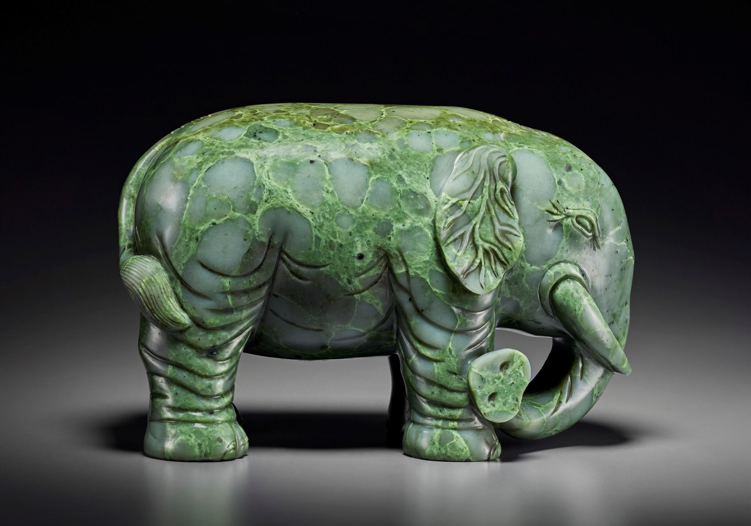 A SUPERB LARGE SPINACH-GREEN JADE FIGURE OF AN ELEPHANT, QIANLONG ...