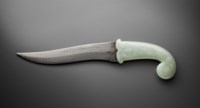A MUGHAL CARVED GREENISH-WHITE JADE DAGGER HANDLE, THE JADE HANDLE ...