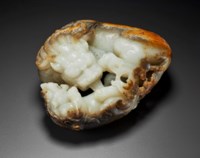 A WHITE, BLACK AND RUSSET JADE CARVING OF A MYTHICAL BEAST AND CUB ...