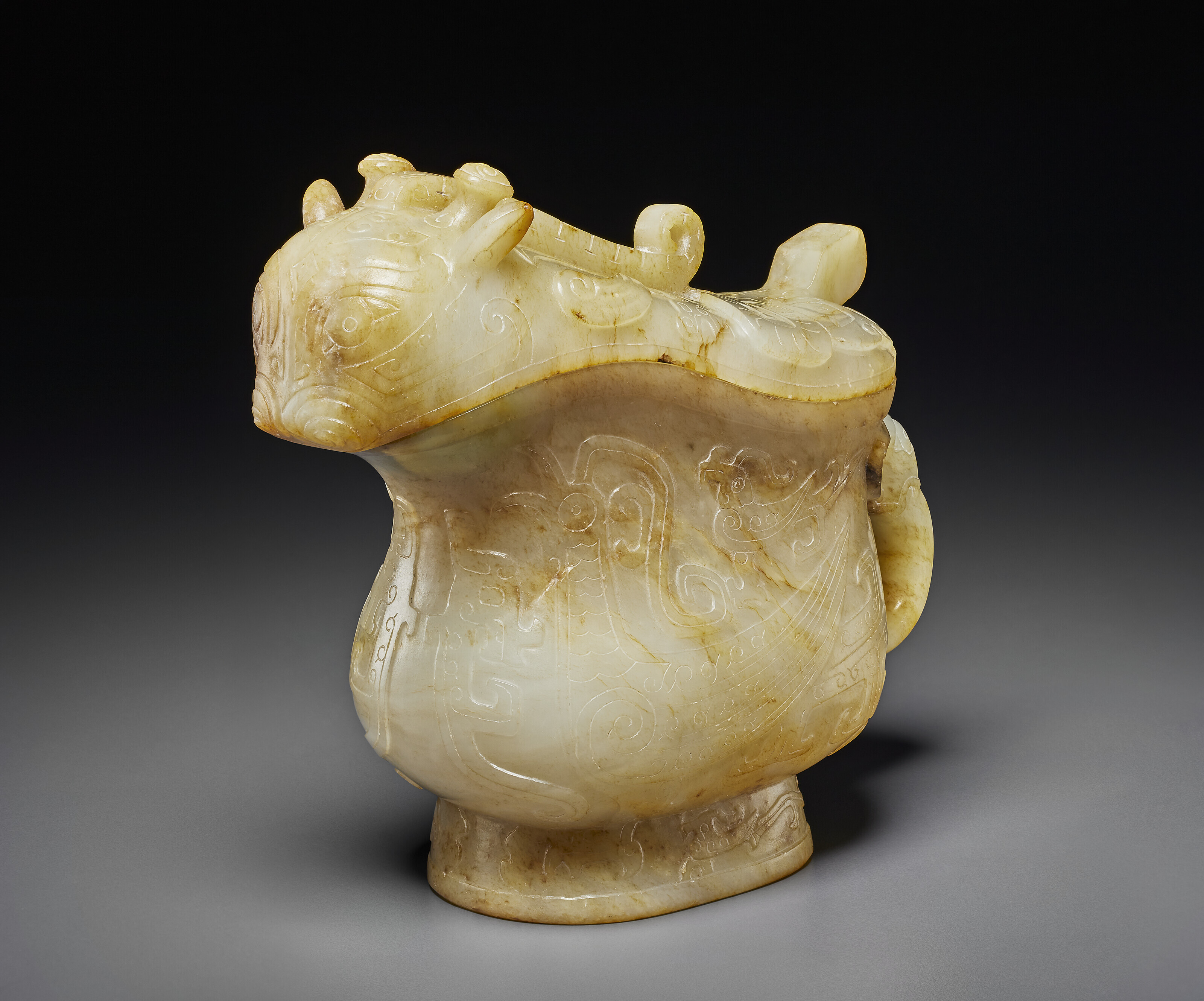 A WHITE, BLACK AND RUSSET JADE CARVING OF A MYTHICAL BEAST AND CUB ...